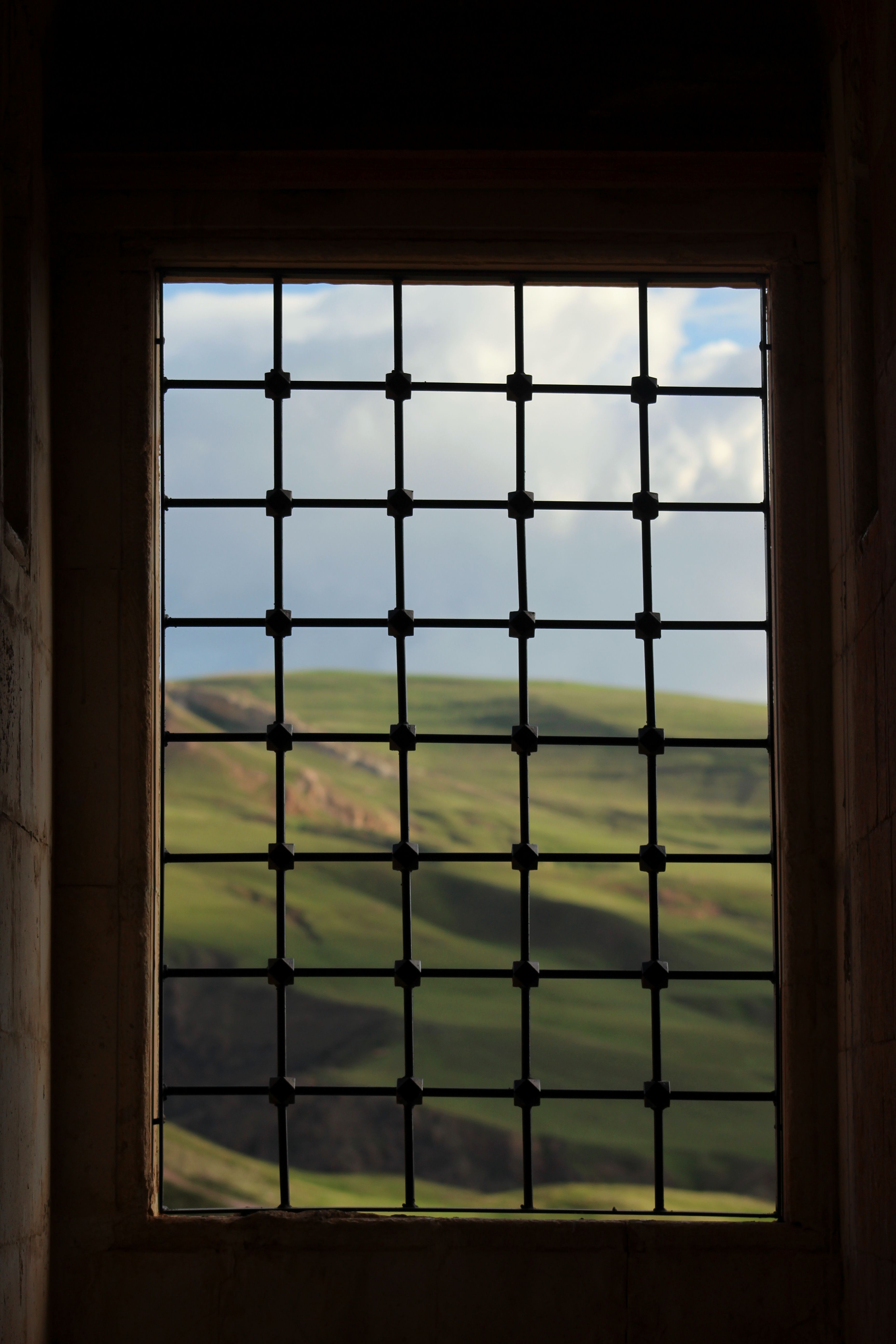 Picturesque Landscape Through Grated Window · Free Stock Photo