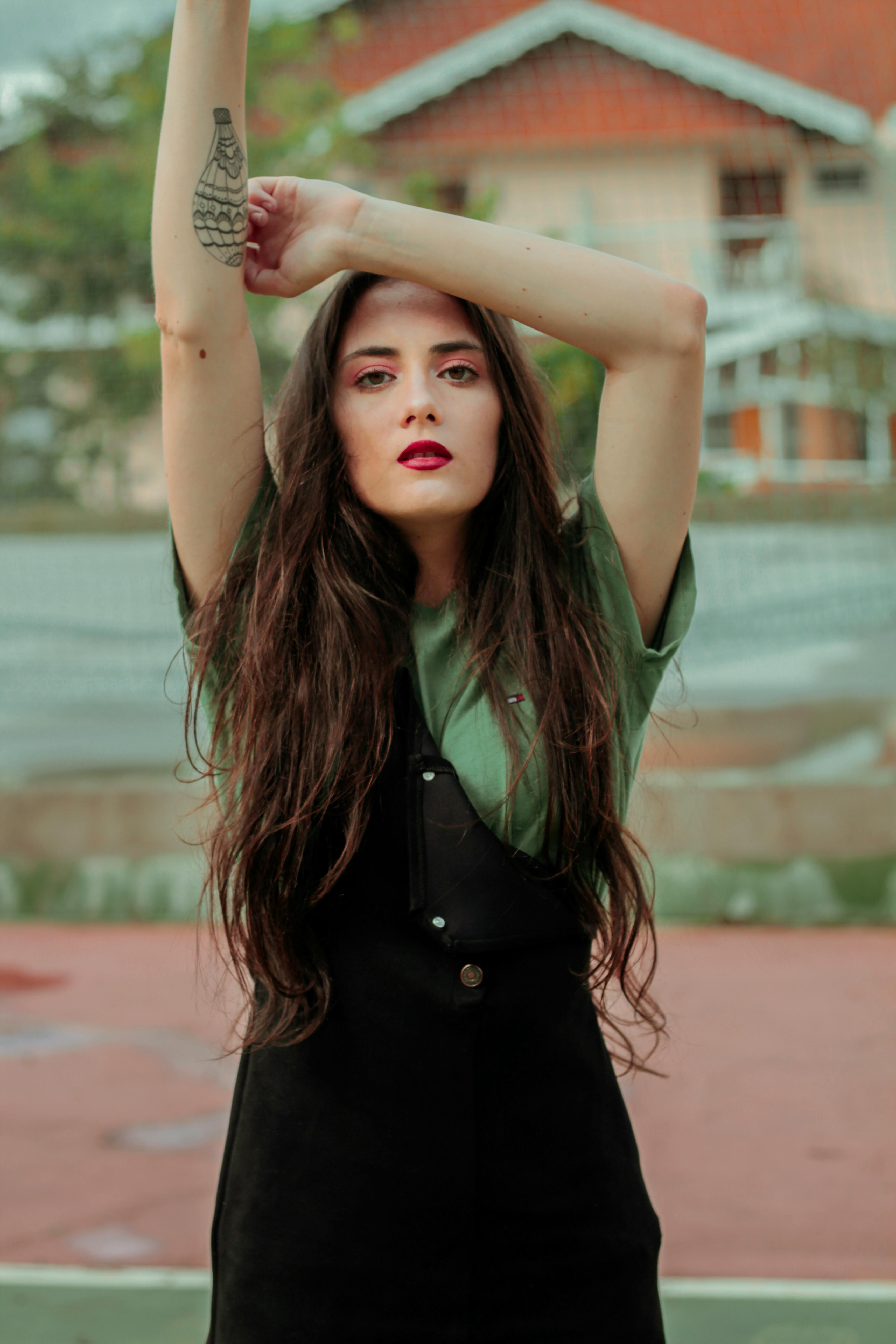 Woman Wearing Black Dress With Right Hand Raise · Free Stock Photo