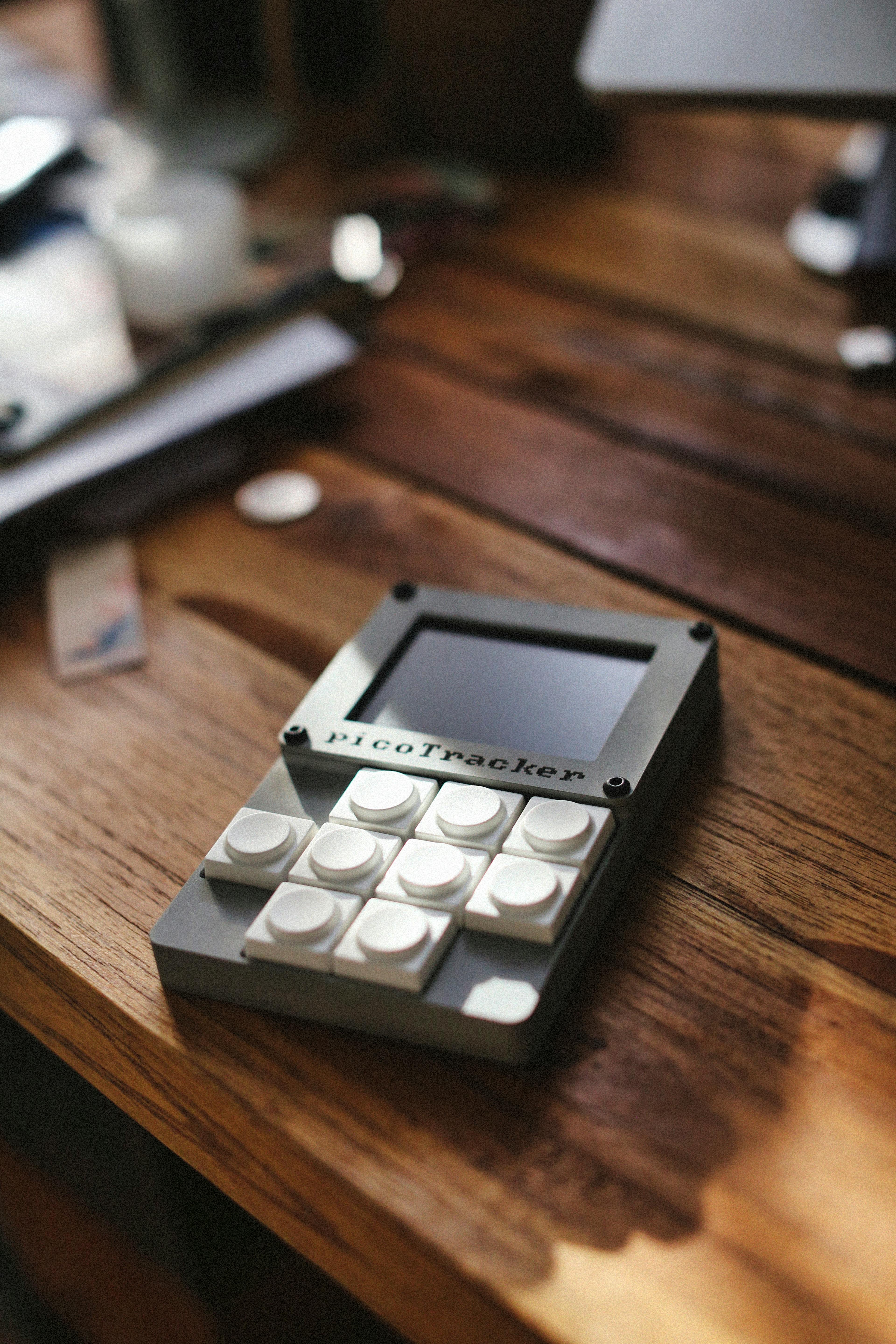 Retro PicoTracker Device on Wooden Desk · Free Stock Photo