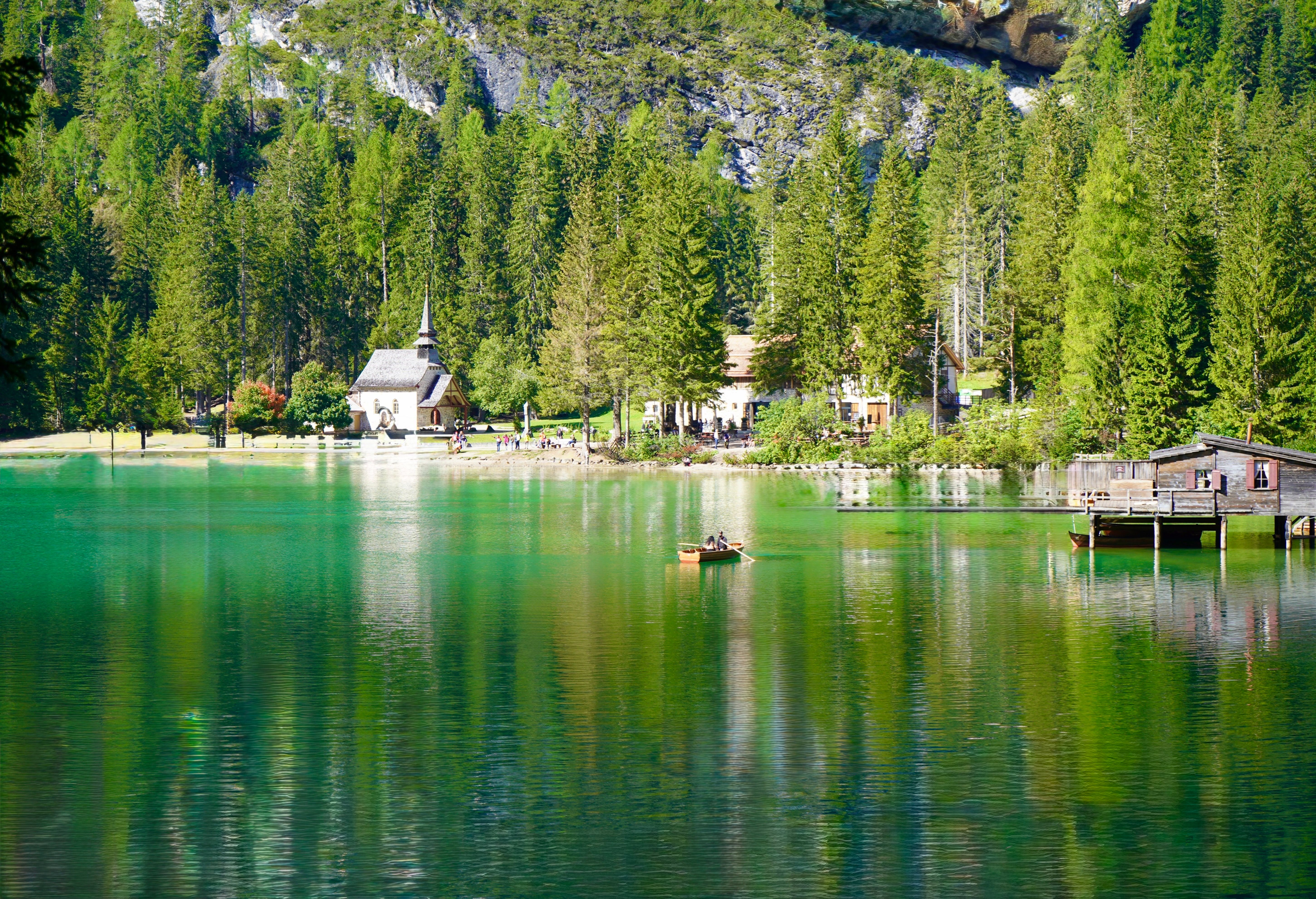 Scenic Alpine Lake with Chapel and Forest · Free Stock Photo