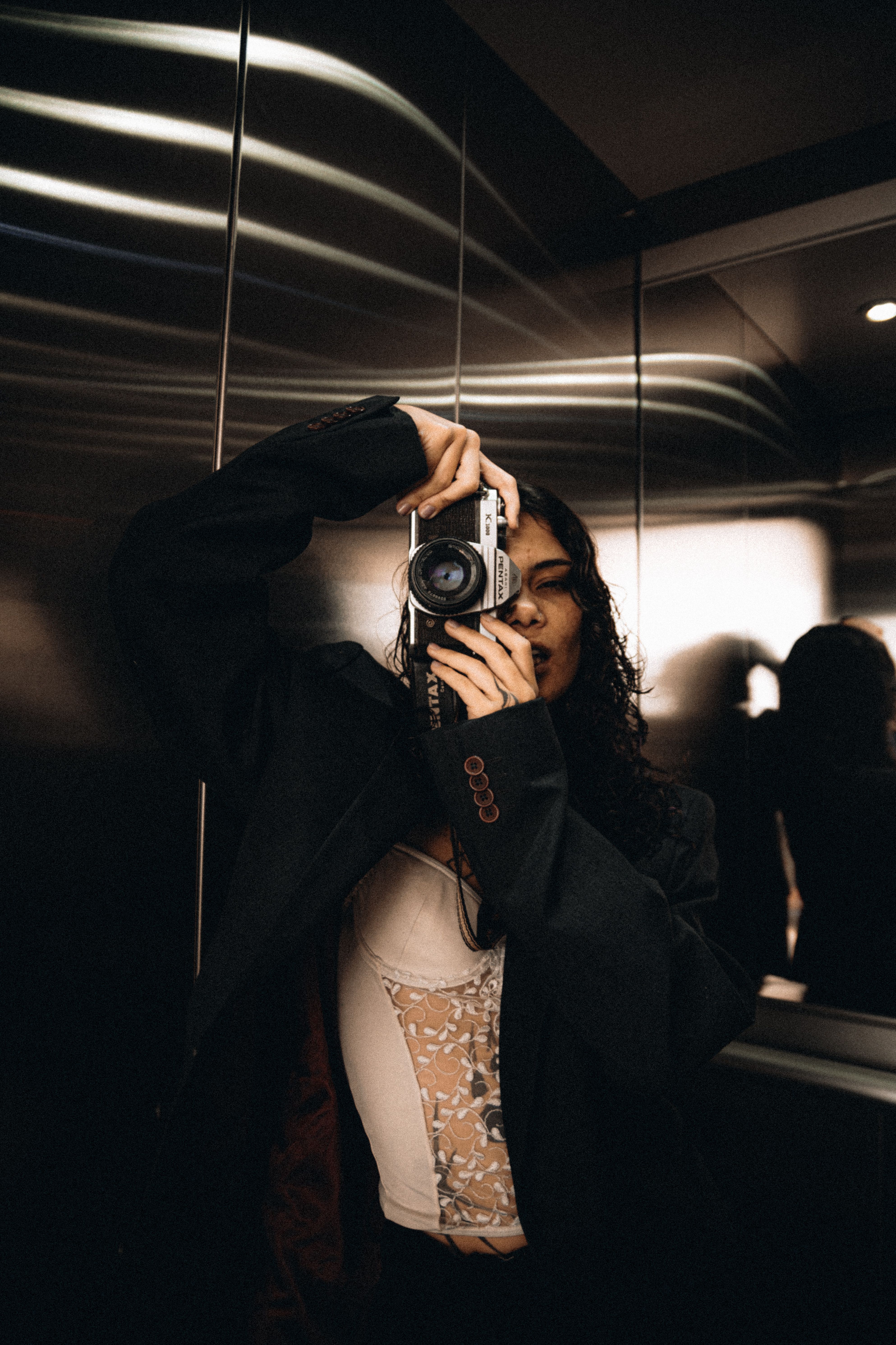 Woman Taking Photo in a Modern Elevator · Free Stock Photo