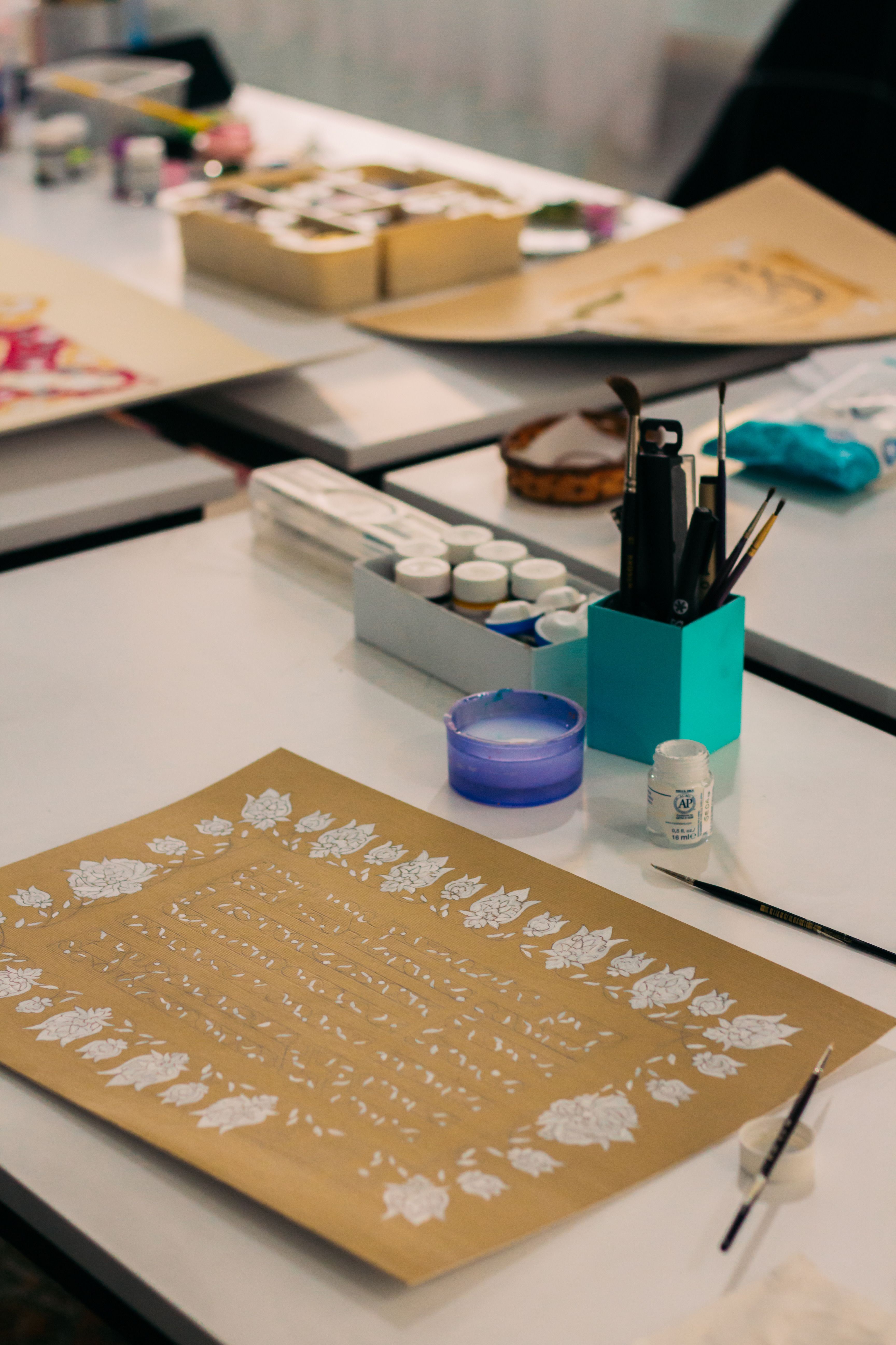 Creative Art Supplies on Artist's Workspace Table · Free Stock Photo