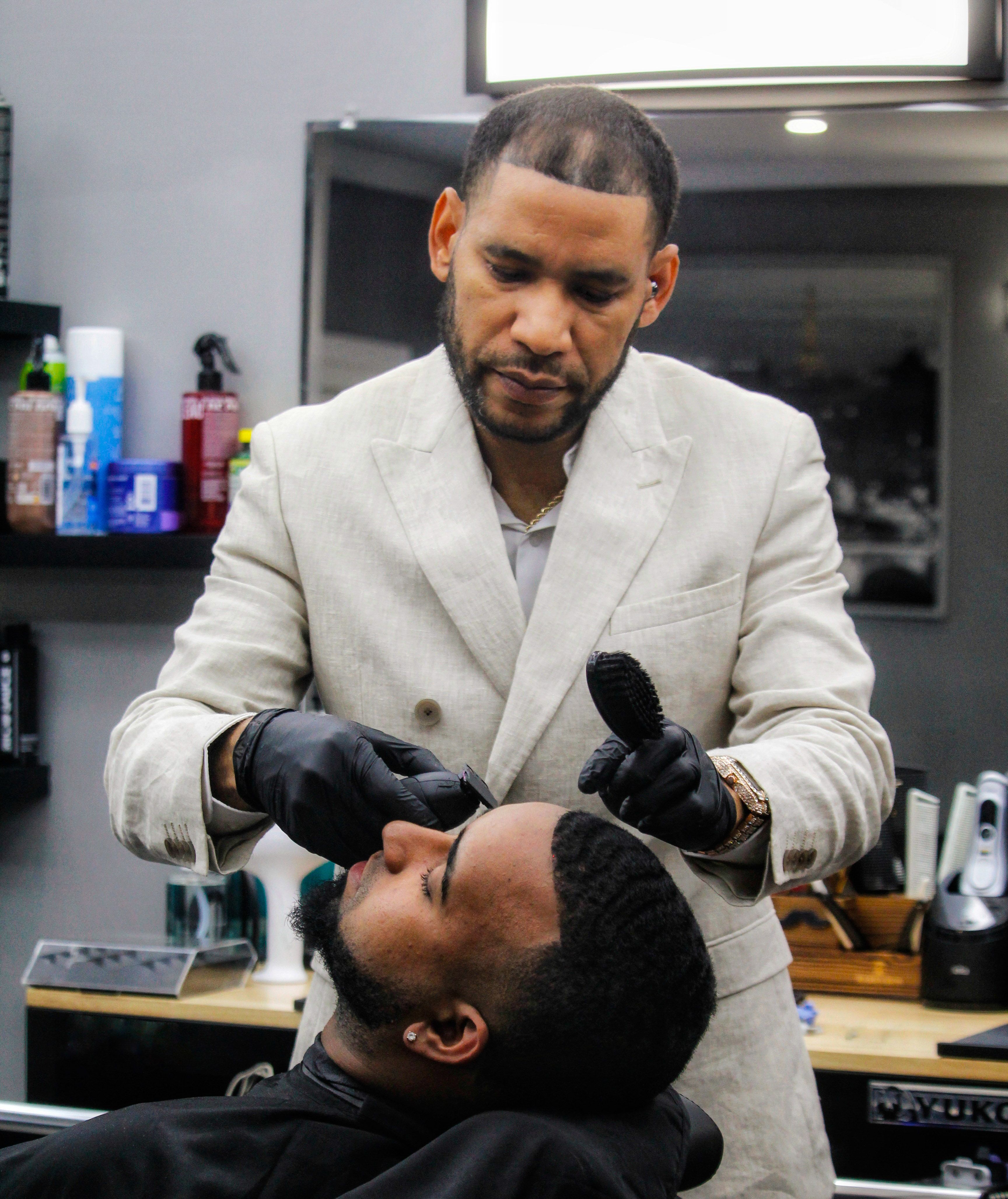 Barber Skillfully Grooming Client's Beard · Free Stock Photo