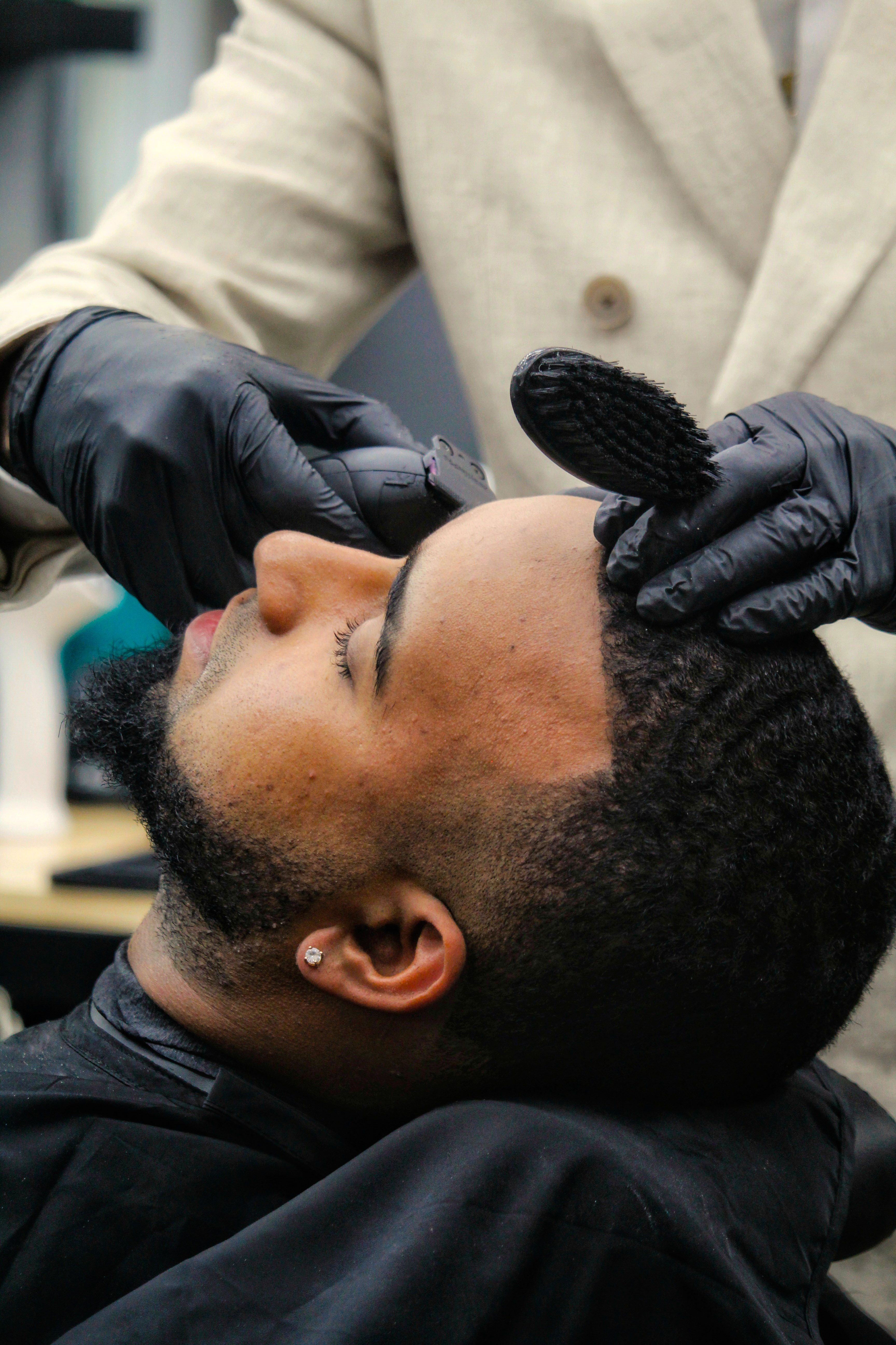 Professional Barber Grooming a Client's Hair · Free Stock Photo