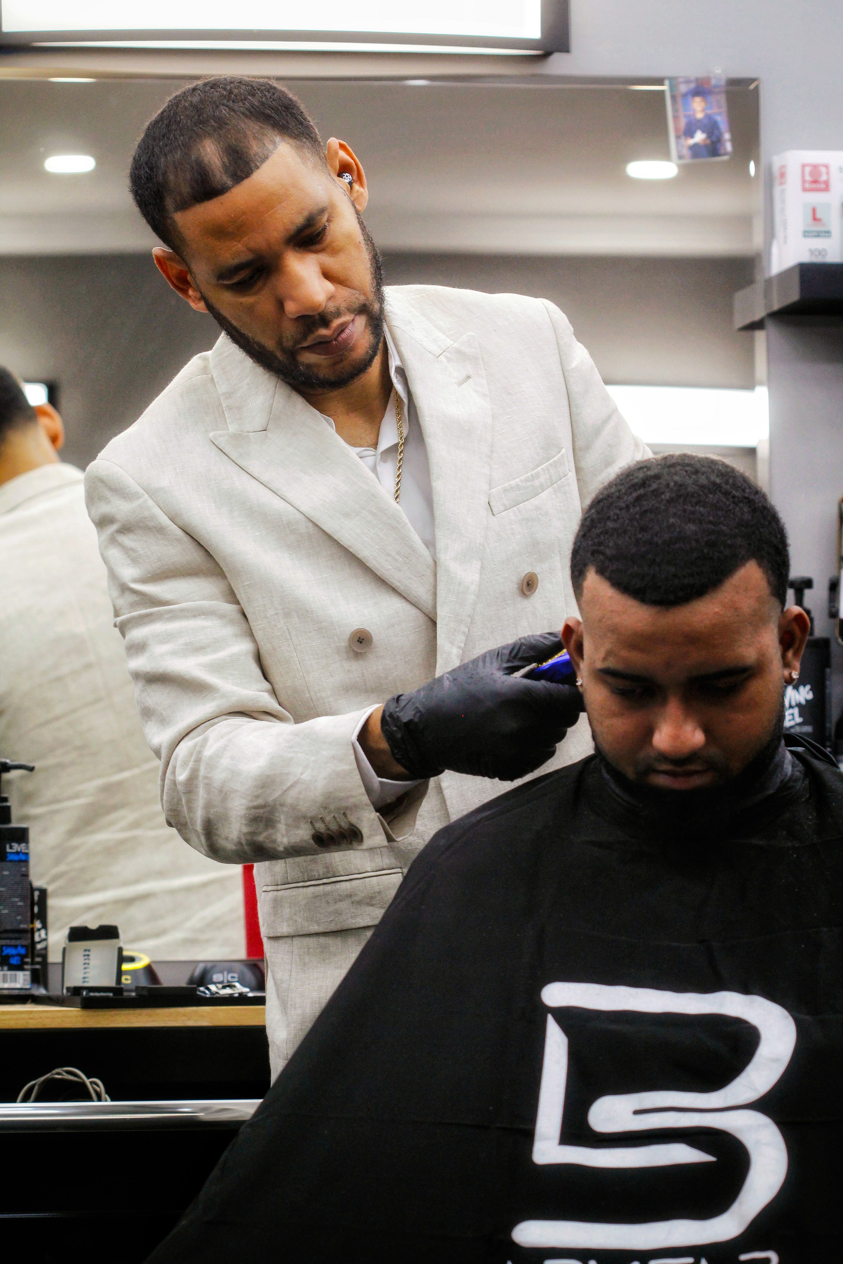 Professional Barber Styling Hair in Modern Salon · Free Stock Photo