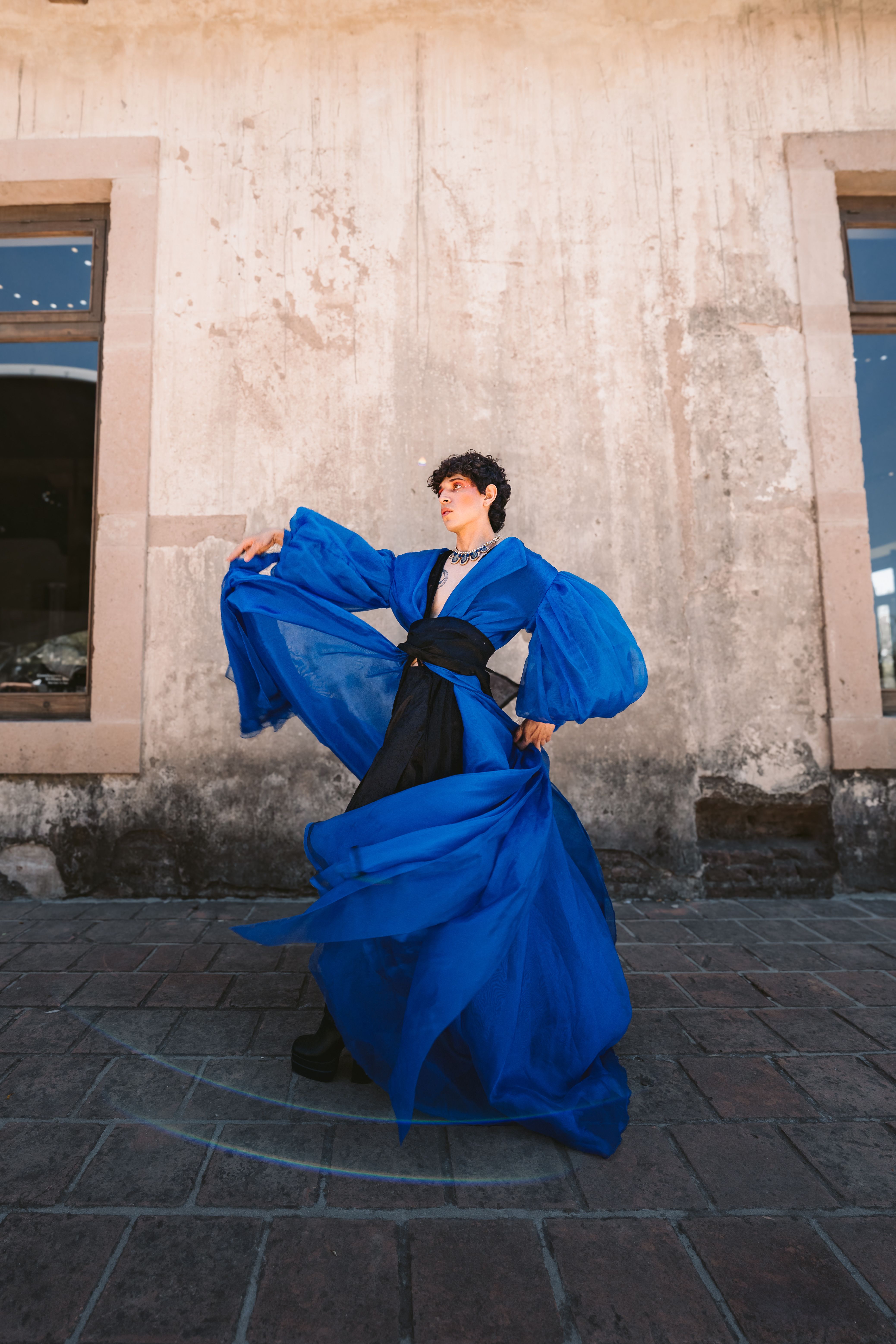 Elegant Woman in Flowing Blue Dress Outdoors · Free Stock Photo