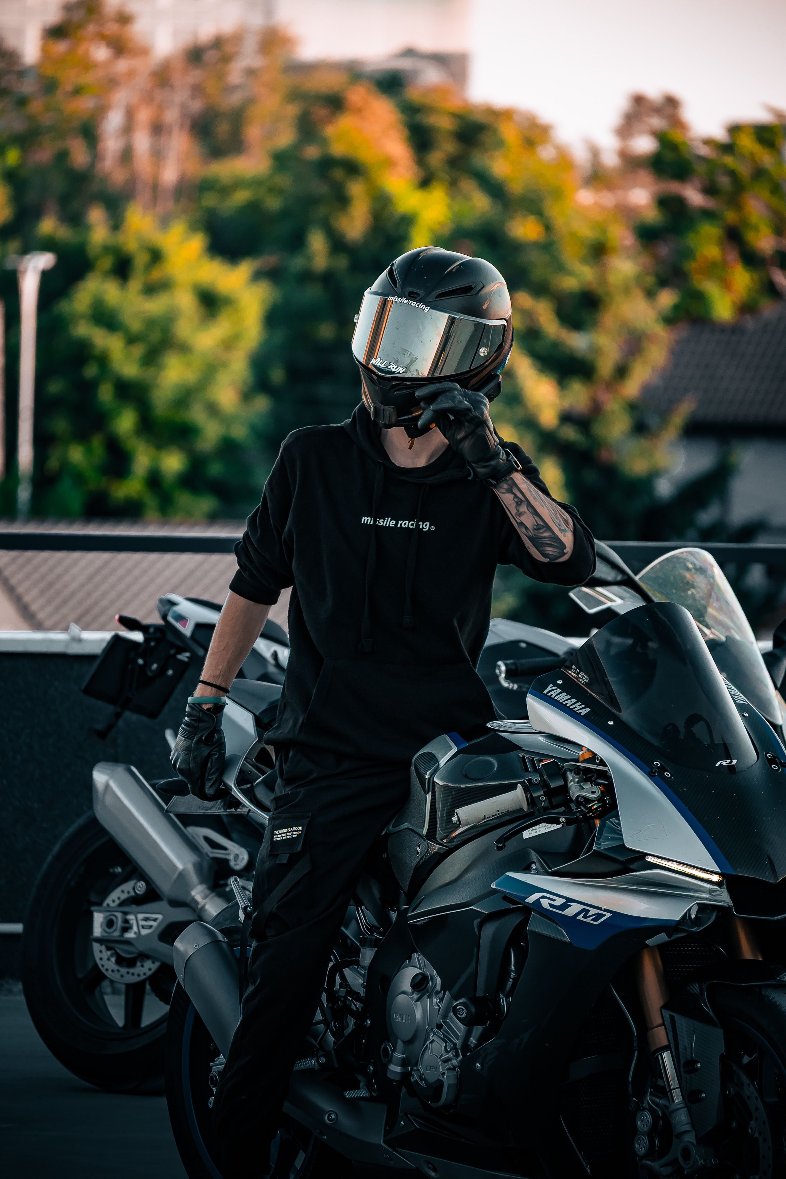 Motorcyclist with Helmet Posing on Sportbike Outdoors · Free Stock Photo