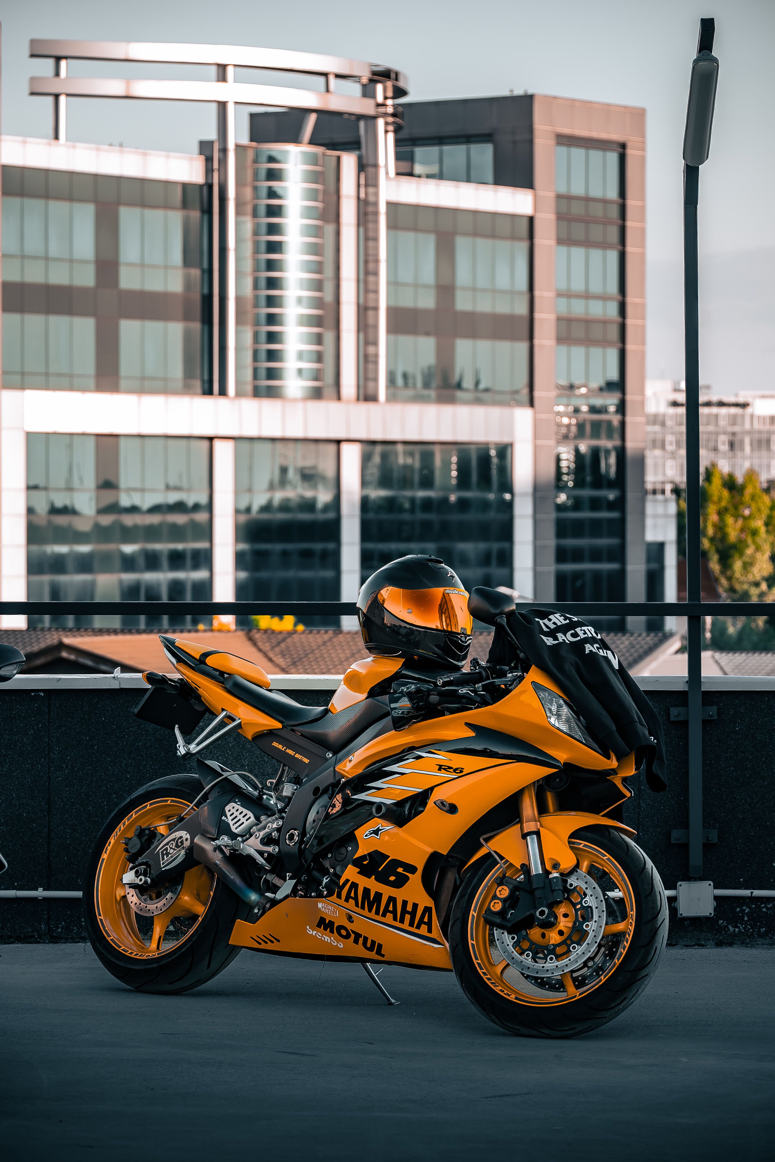 Vibrant Orange Sports Motorcycle on City Rooftop · Free Stock Photo