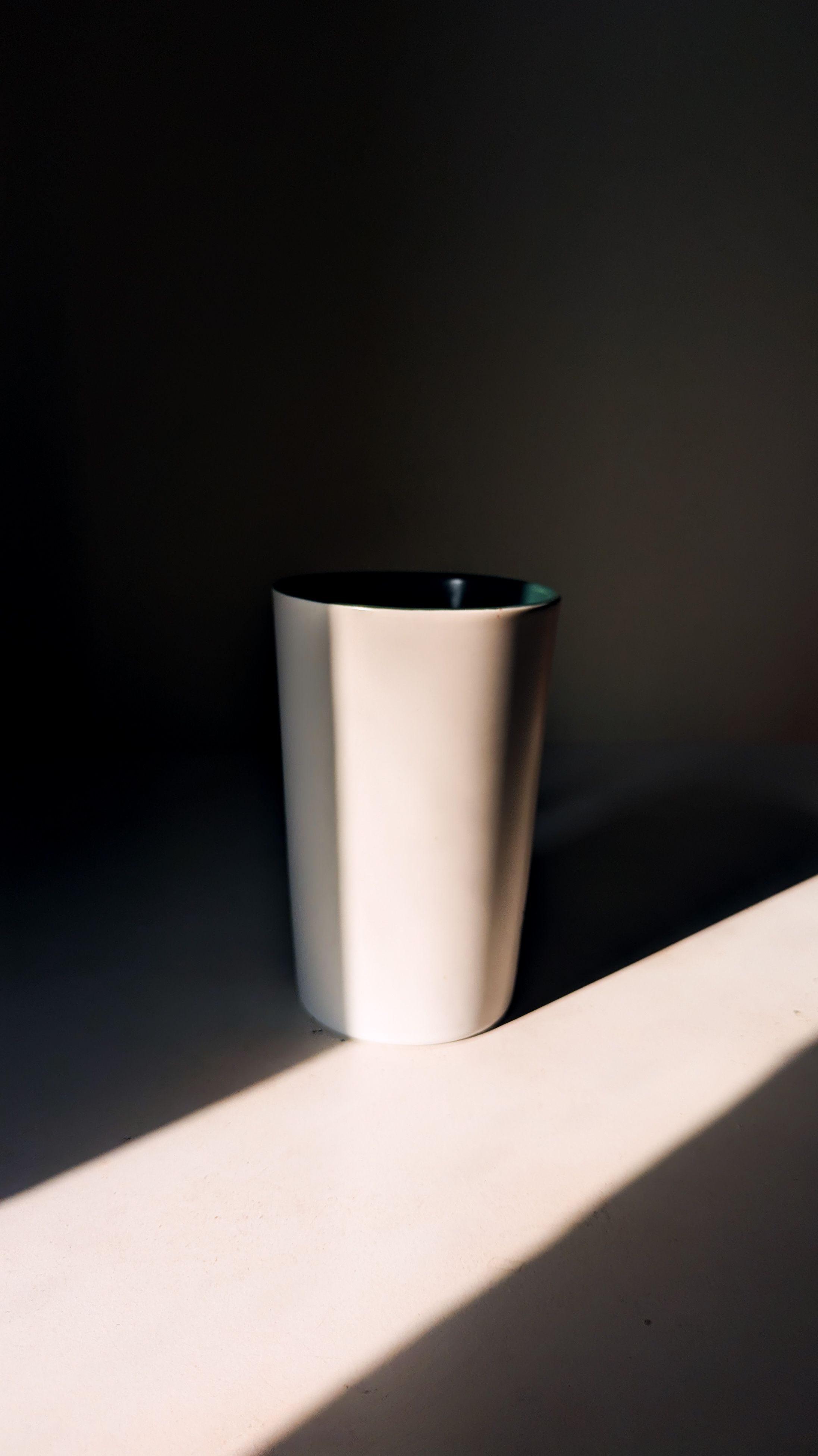 Minimalist White Cup in Deep Shadows · Free Stock Photo