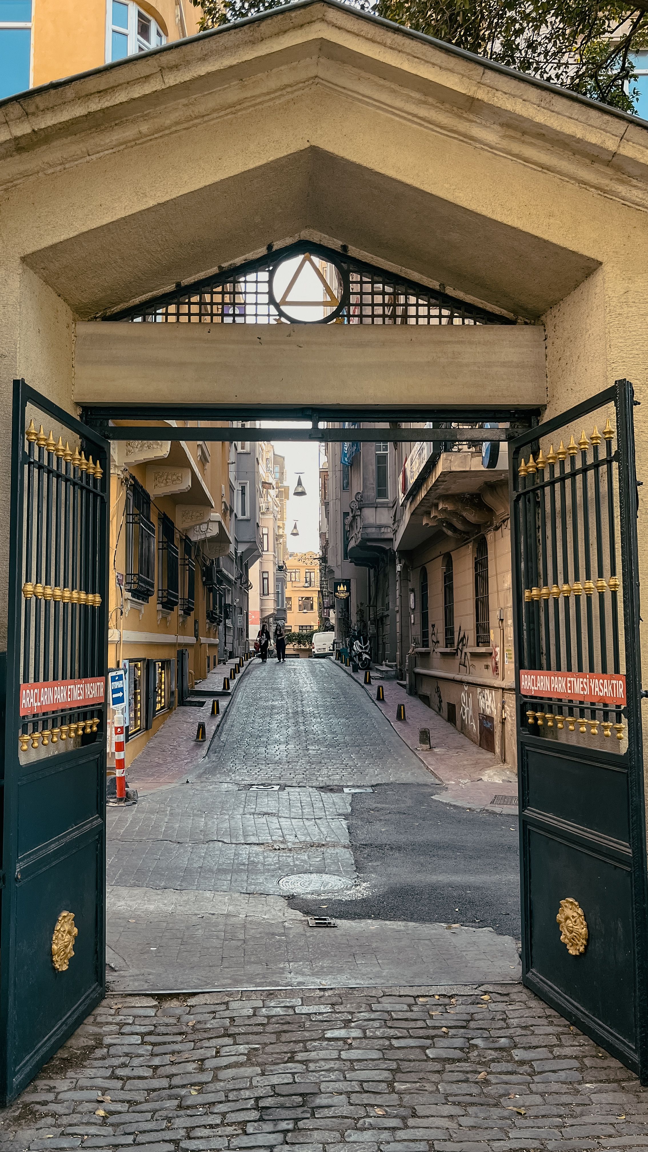 Charming European Alleyway Framed by Open Gate · Free Stock Photo