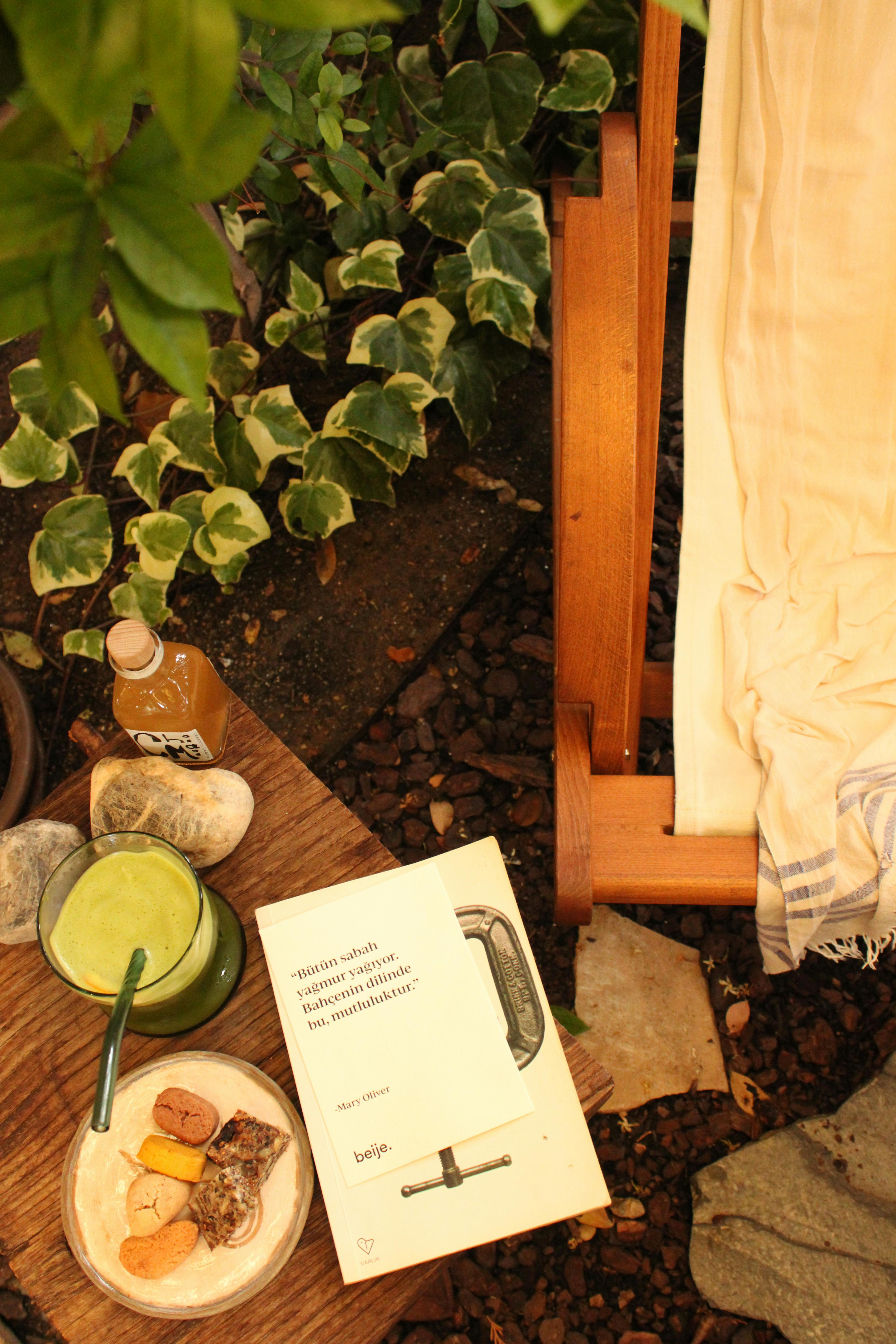 Cozy Outdoor Reading Nook with Snacks and Drink · Free Stock Photo