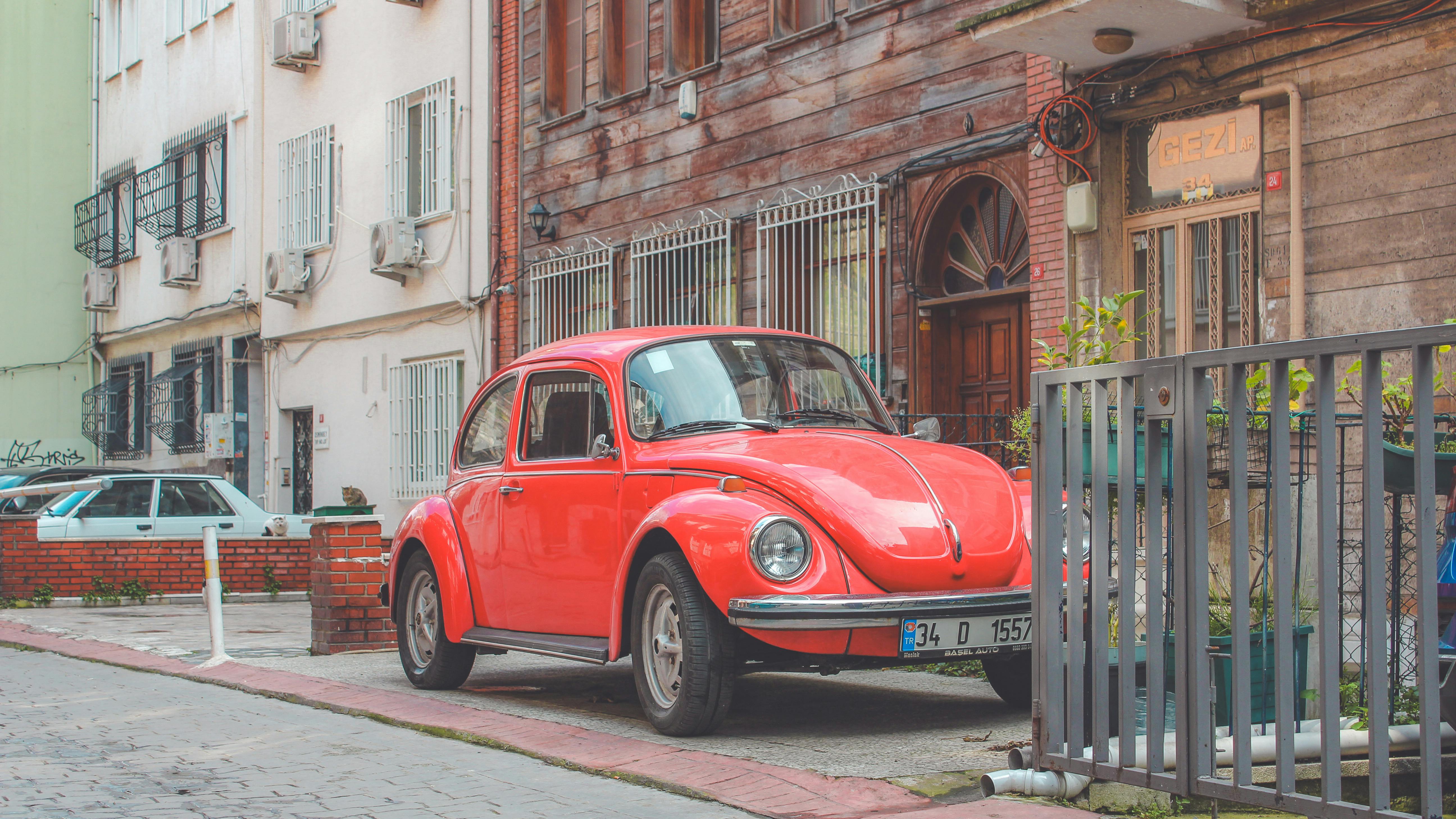 Vintage Red Beetle Car on Charming Urban Street · Free Stock Photo