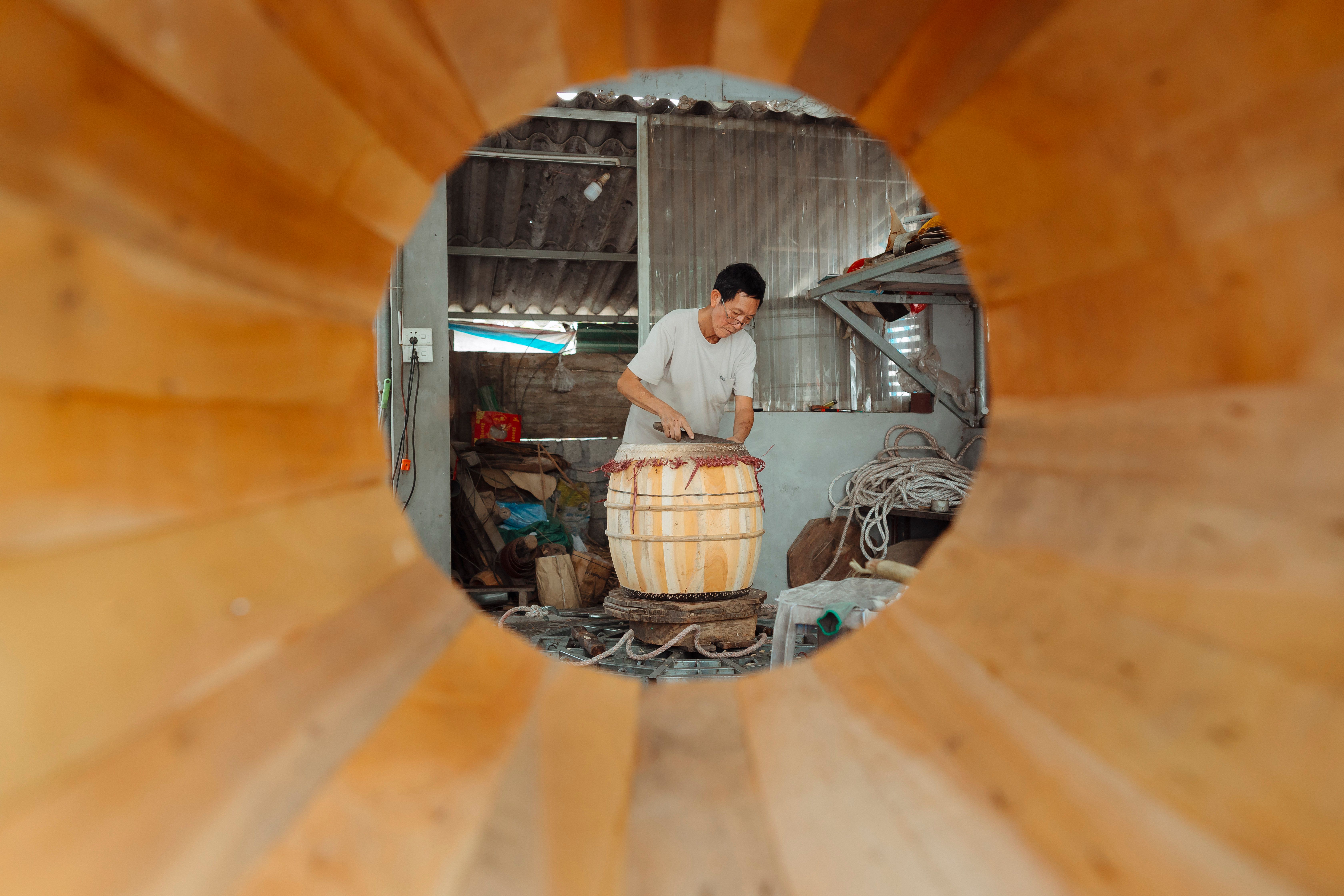 Craftsman Working on Wooden Barrel in Workshop · Free Stock Photo