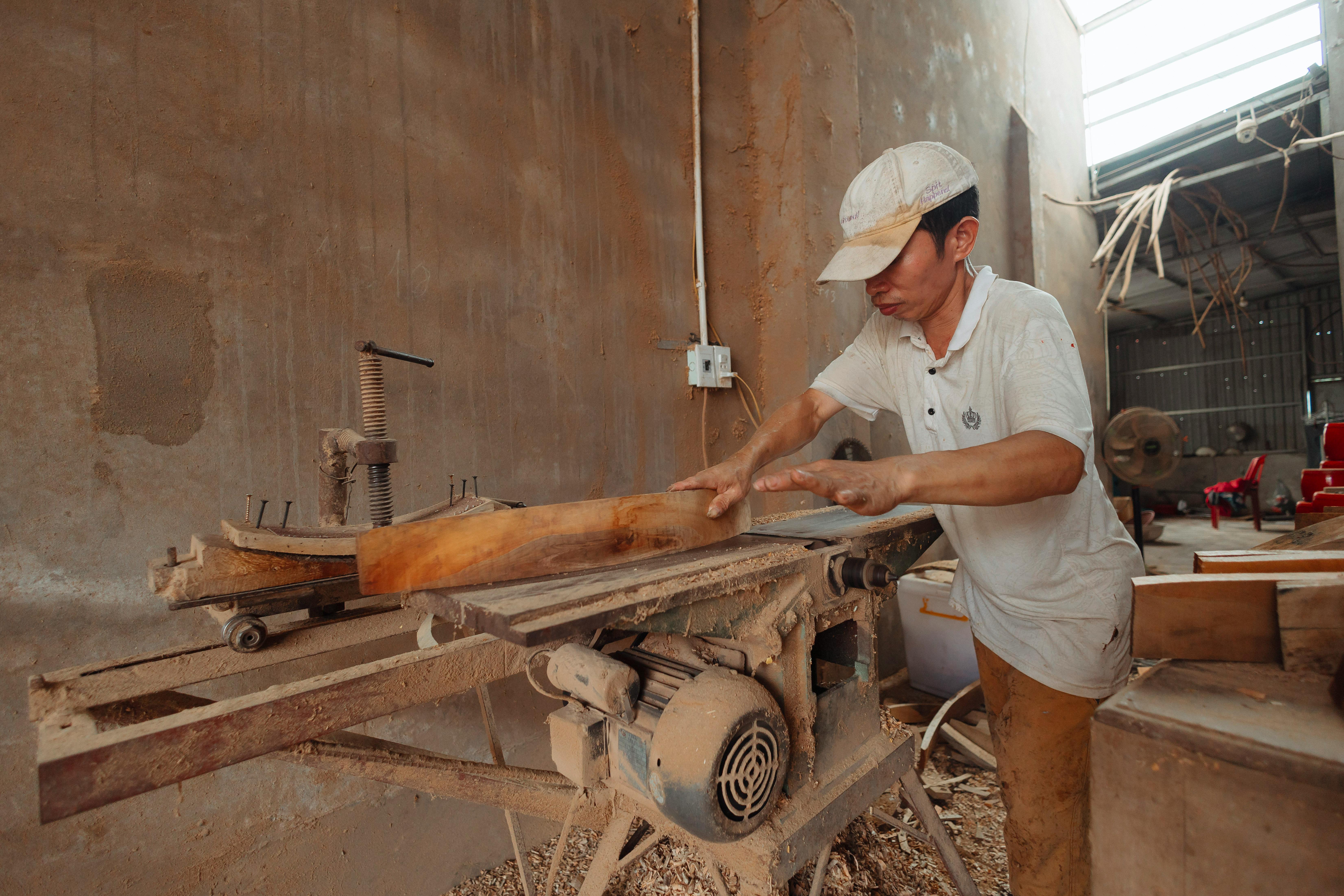 Carpenter Working with Wood on Industrial Saw · Free Stock Photo