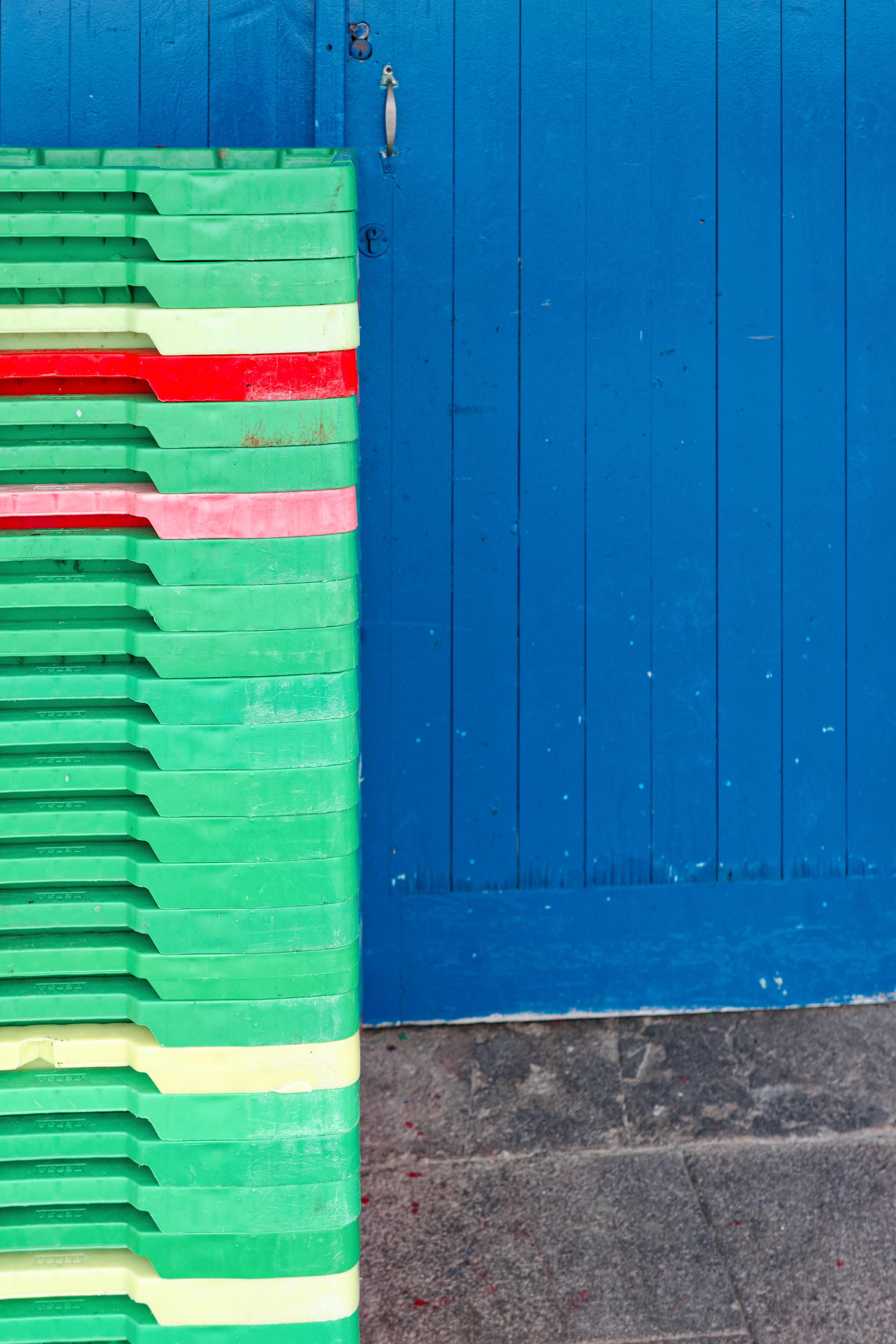 Colorful Stack of Fishing Crates by Blue Door · Free Stock Photo