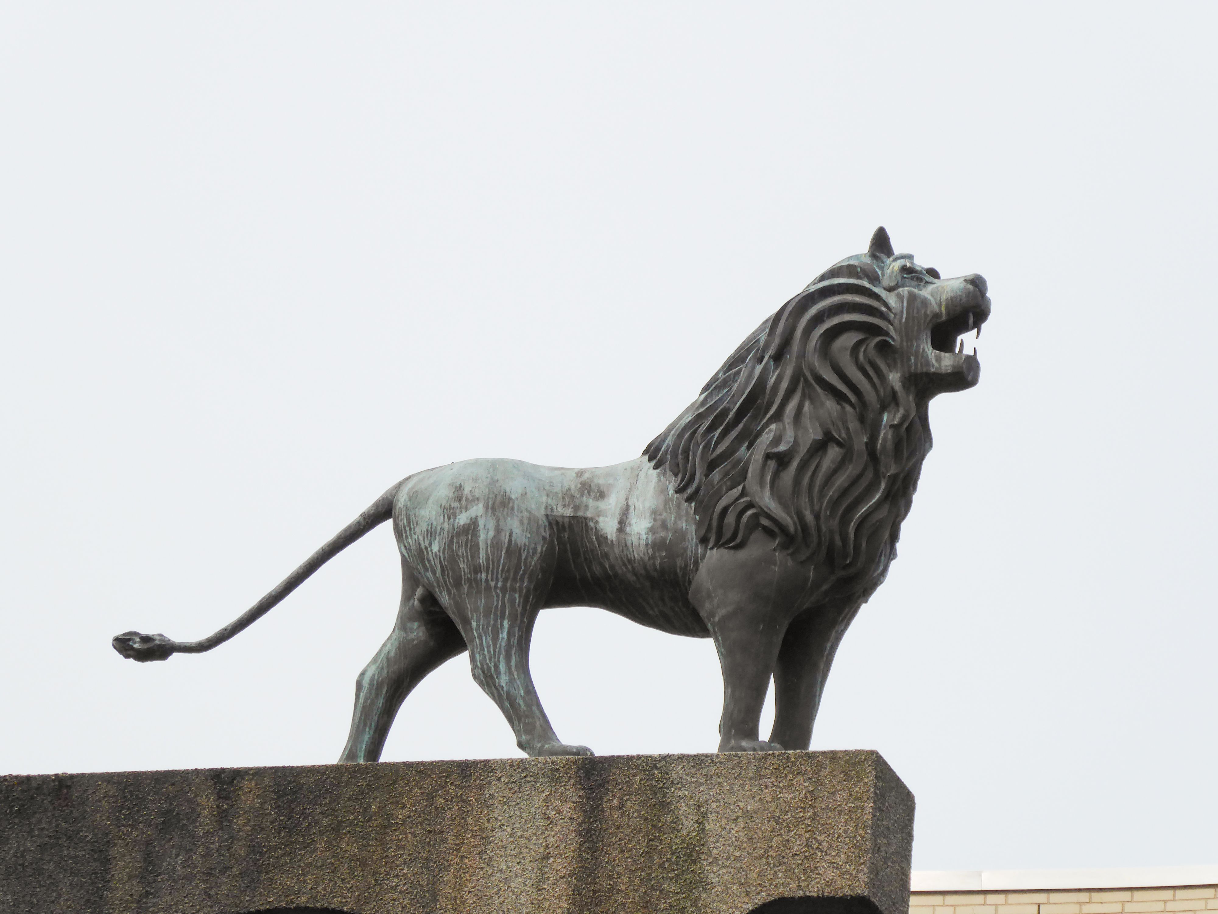 Majestic Lion Statue on Stone Plinth · Free Stock Photo