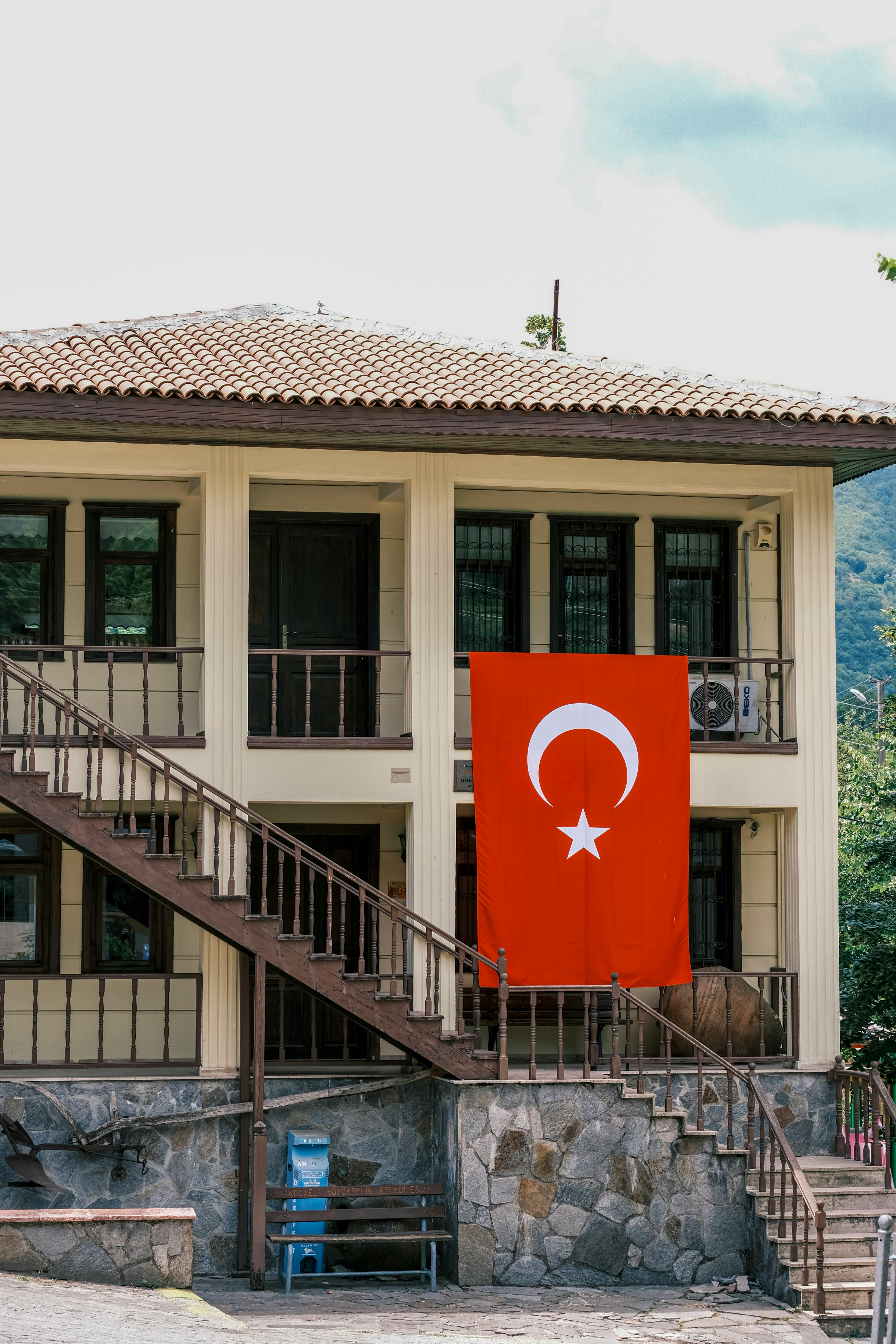 Historic Turkish Building with National Flag Displayed · Free Stock Photo