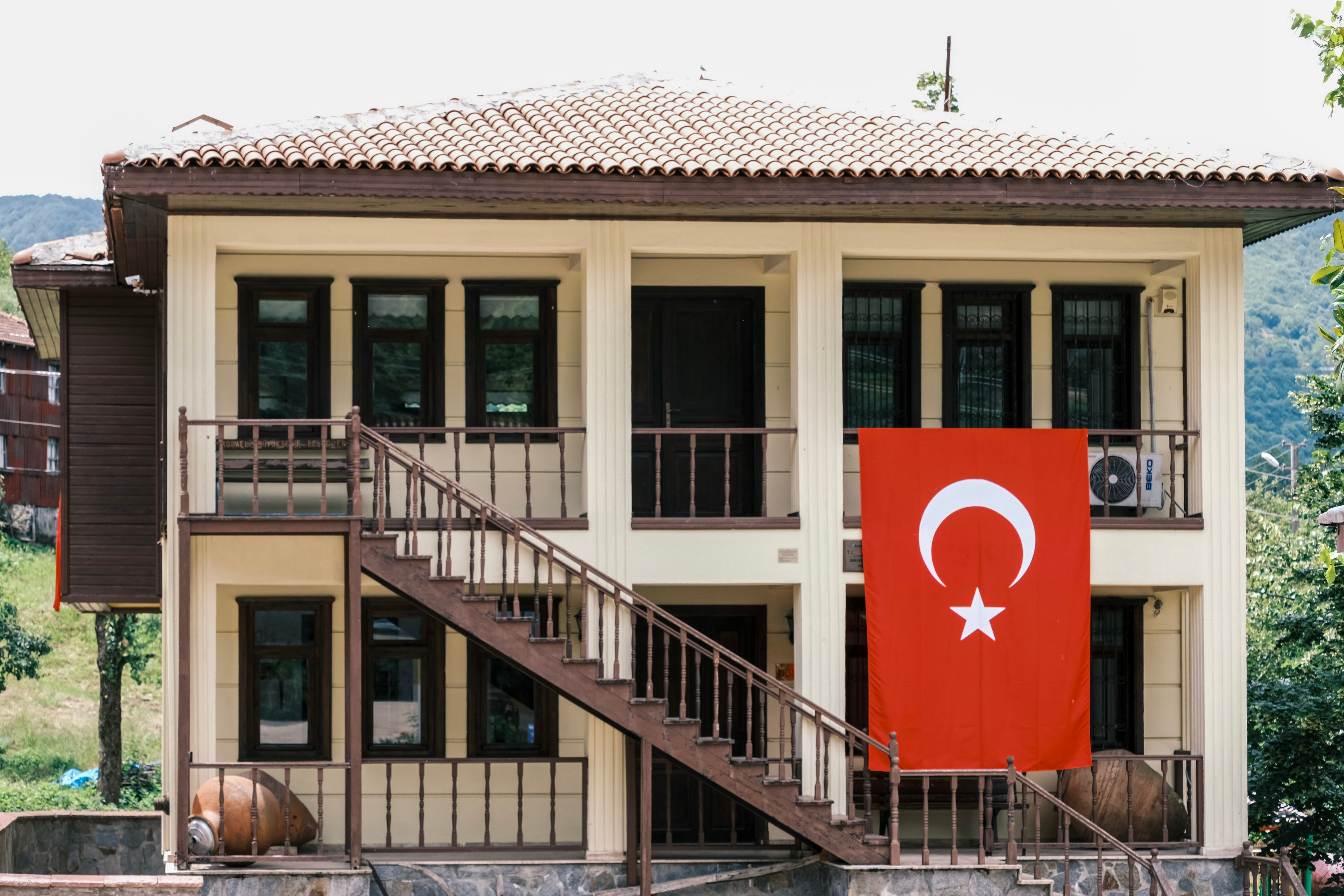 Traditional Turkish House with National Flag Displayed · Free Stock Photo