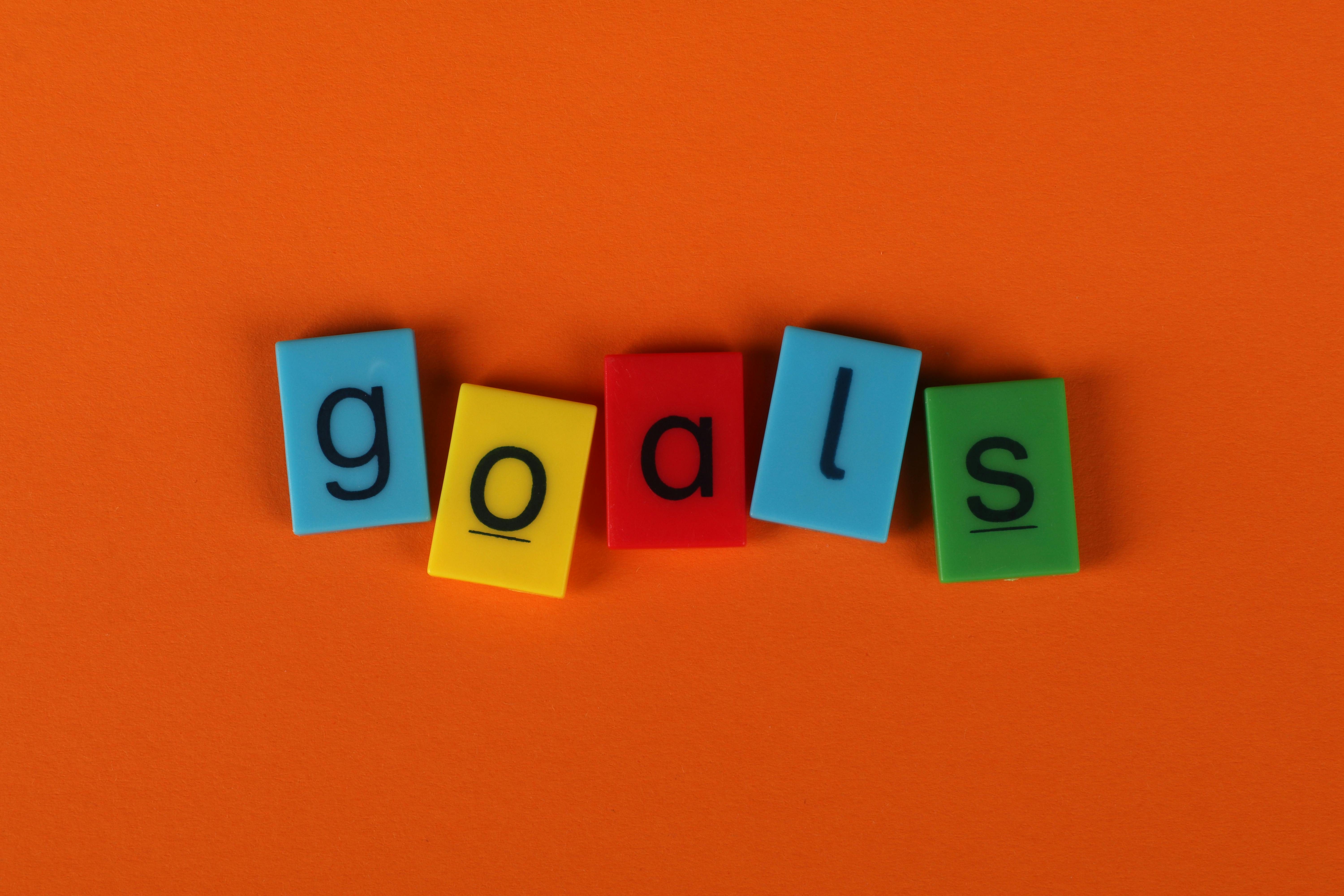Colorful Block Letters Spelling 'Goals' on Orange · Free Stock Photo