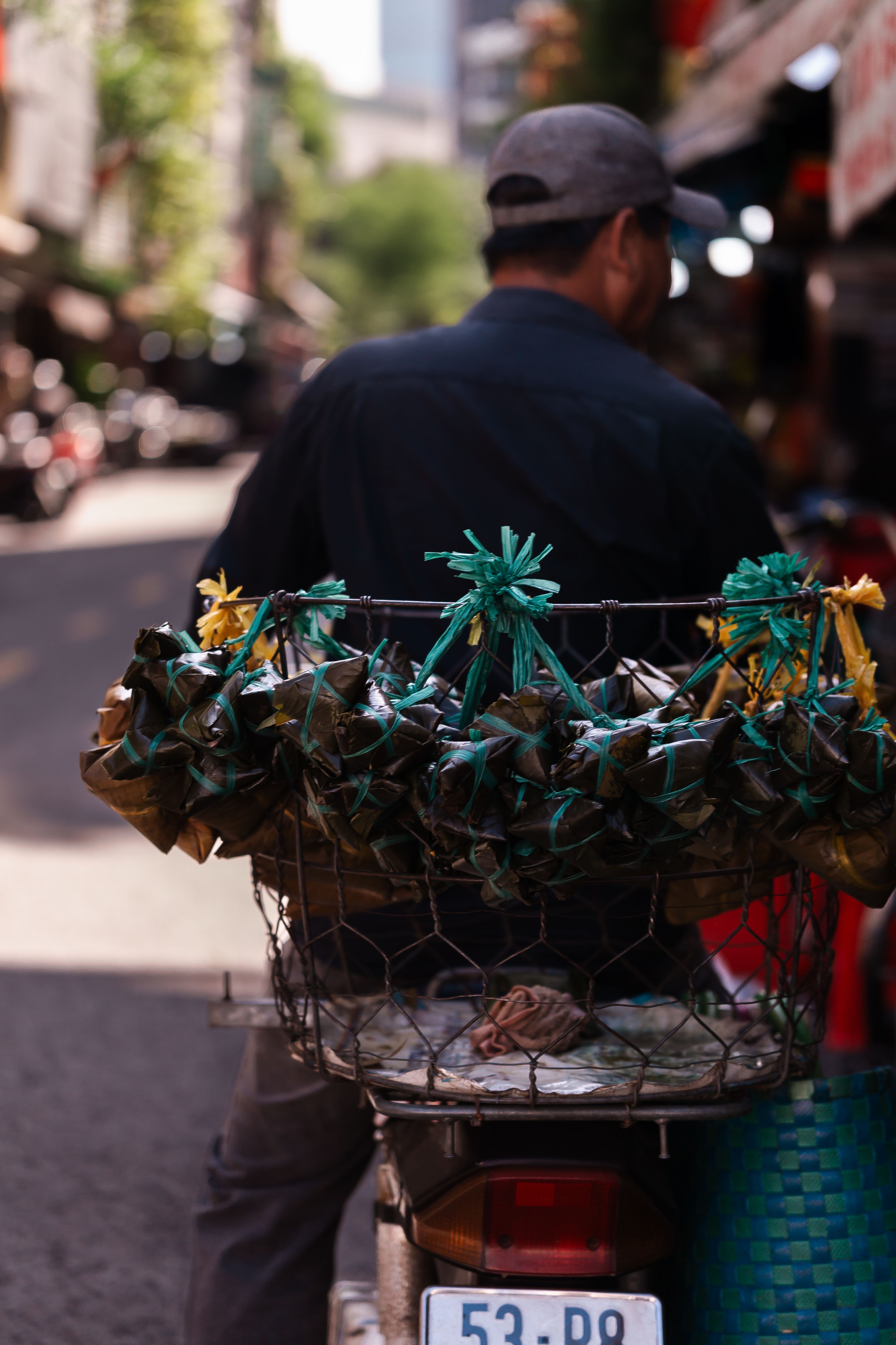 Street Vendor with Wrapped Packages on Motorcycle · Free Stock Photo