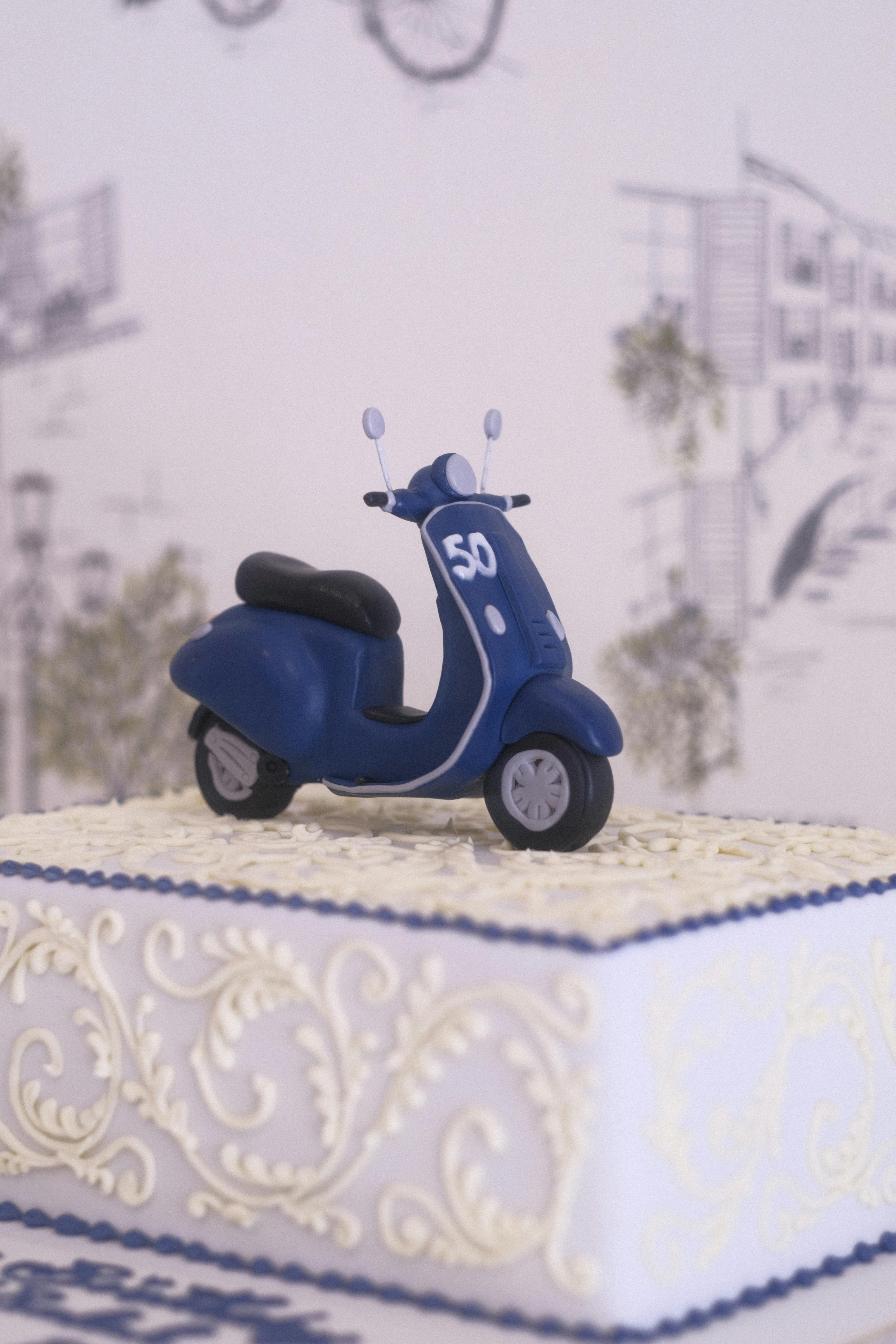 Blue Scooter Cake Topper on Elegant Birthday Cake · Free Stock Photo
