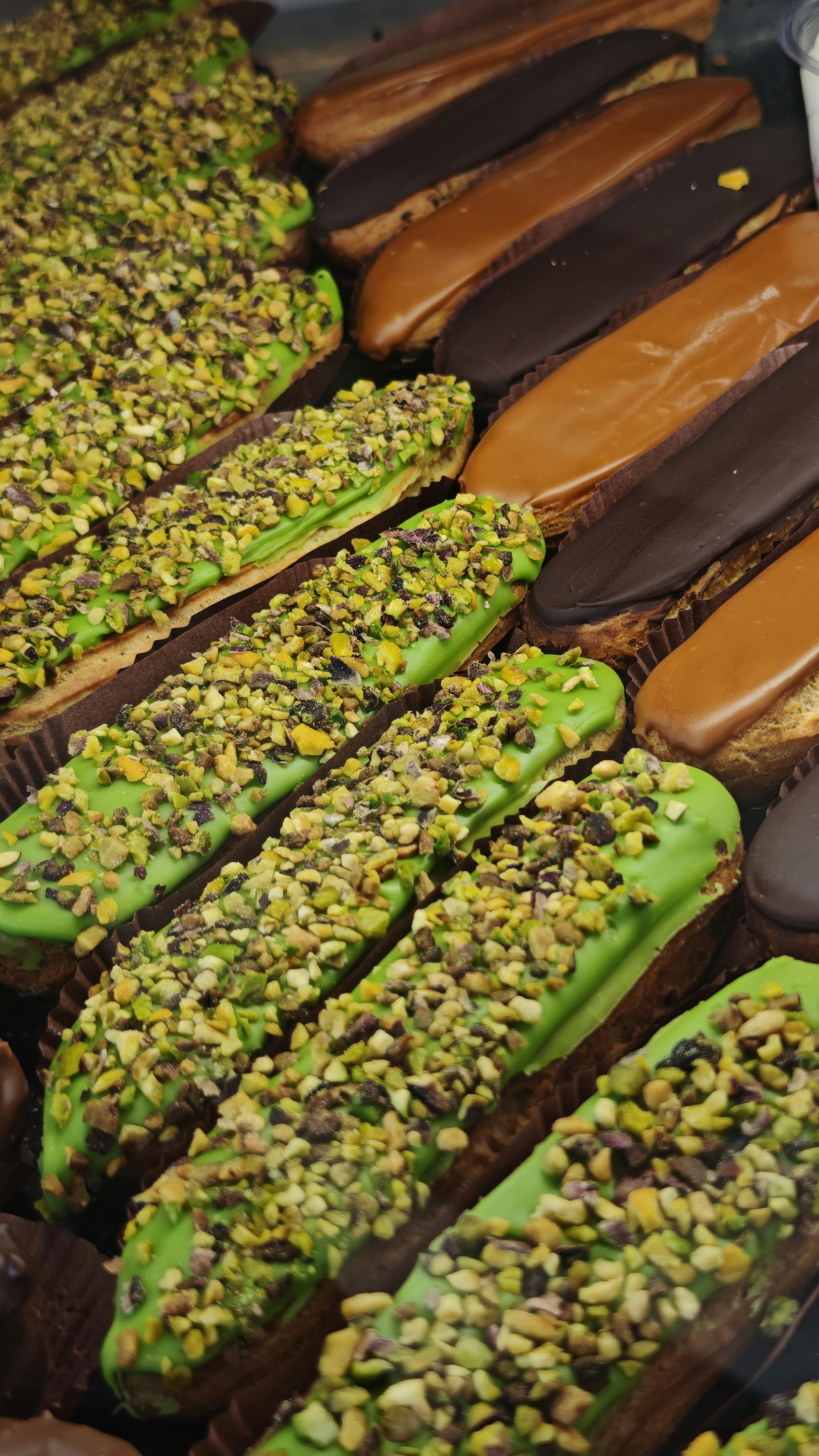 Delicious Assorted Eclairs with Pistachio and Chocolate · Free Stock Photo