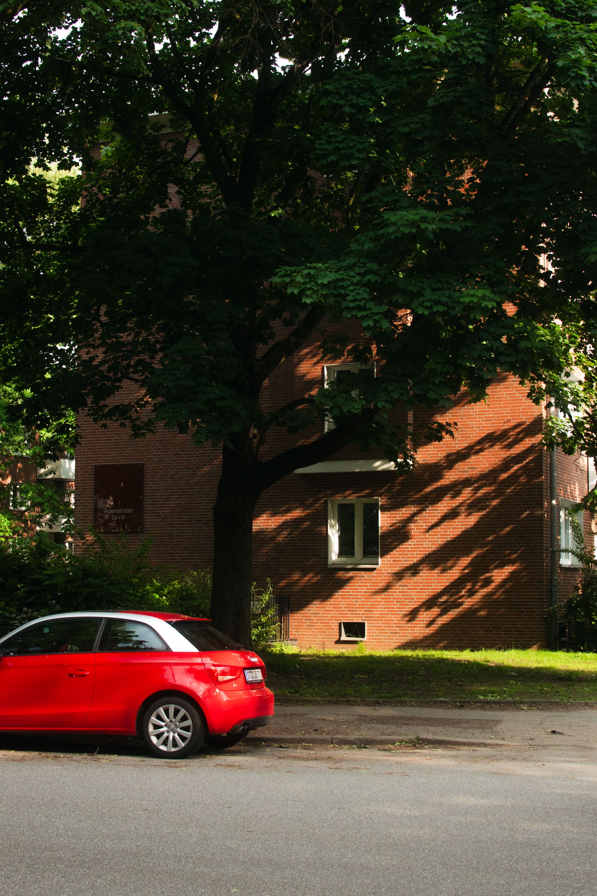 Classic Red Car in Suburban Neighborhood Street · Free Stock Photo