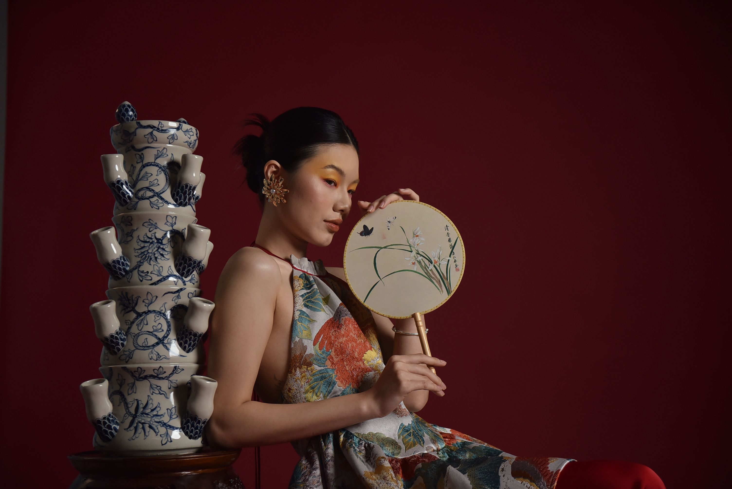 Elegant Woman Holding Artistic Fan in Studio Portrait · Free Stock Photo
