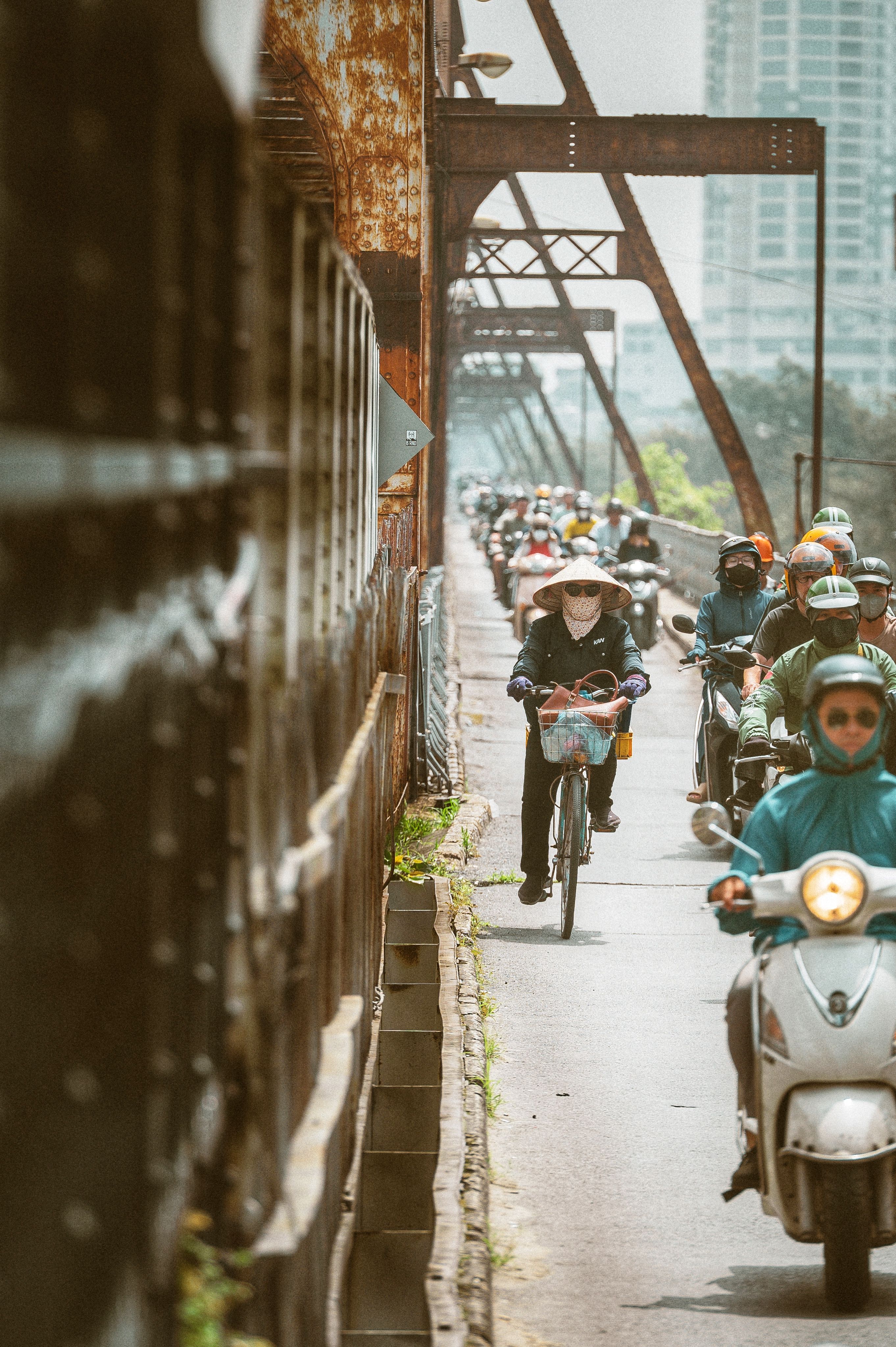 Bustling City Bridge with Motorbikes and Cyclists · Free Stock Photo