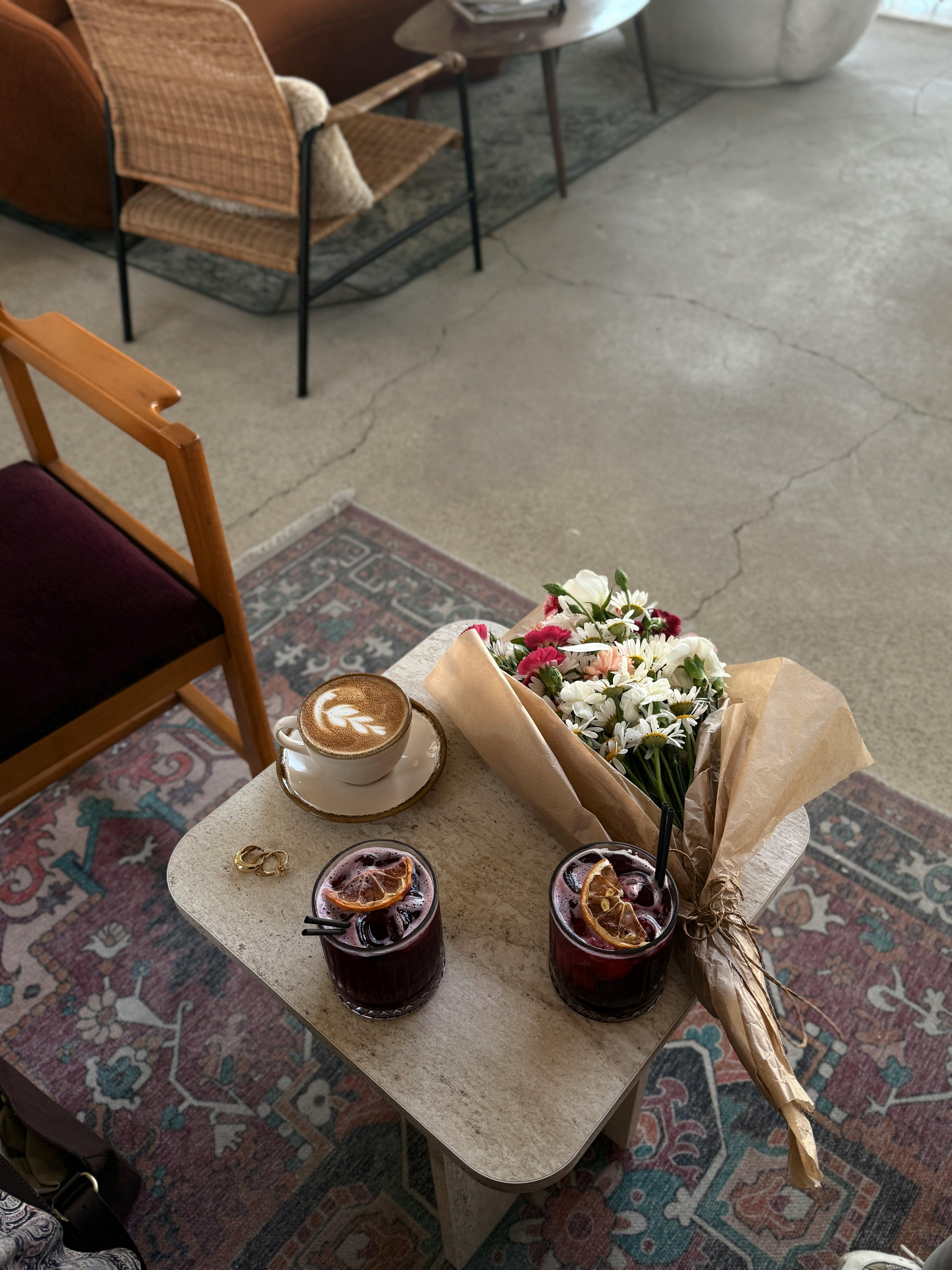 Cozy Coffee Table with Flowers and Drinks · Free Stock Photo