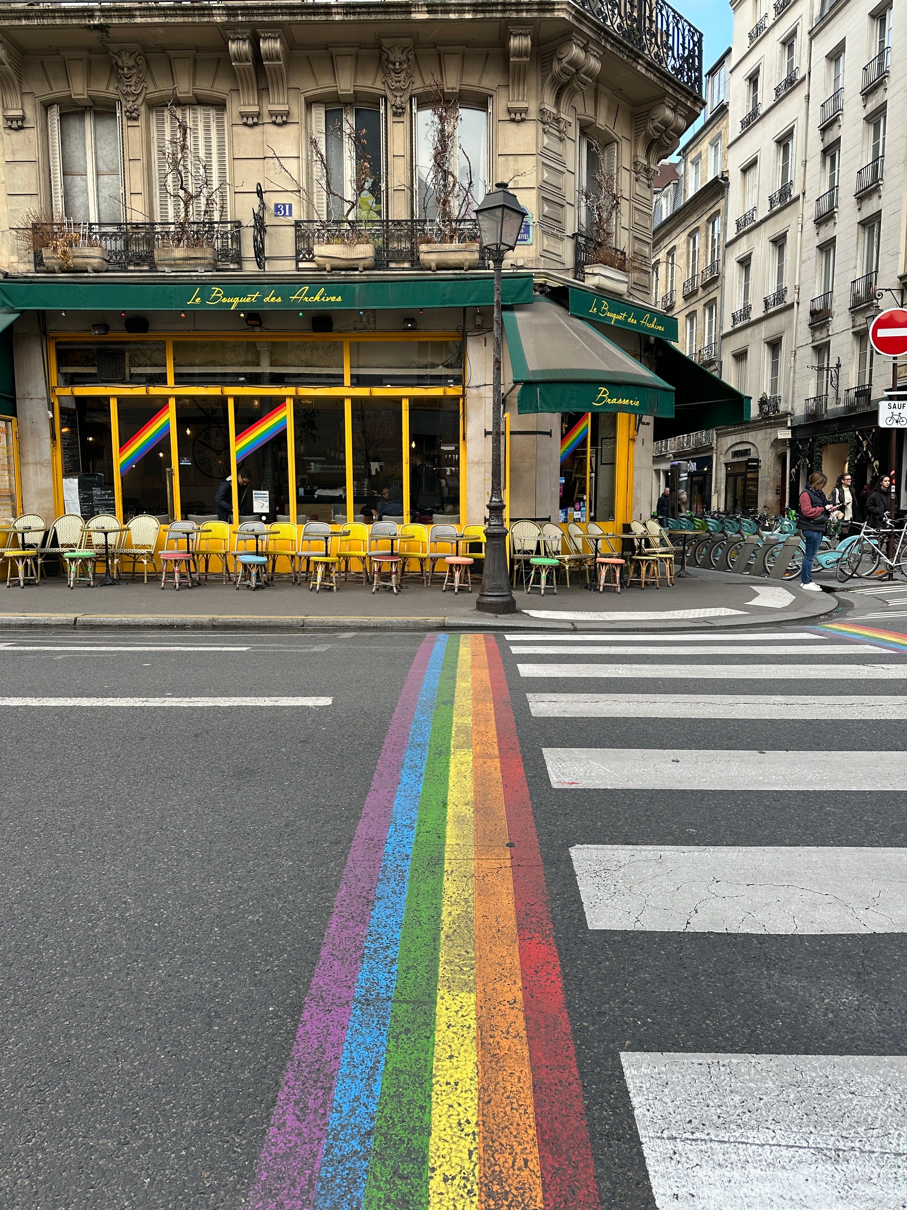 Vibrant Parisian Street with Rainbow Crosswalk · Free Stock Photo