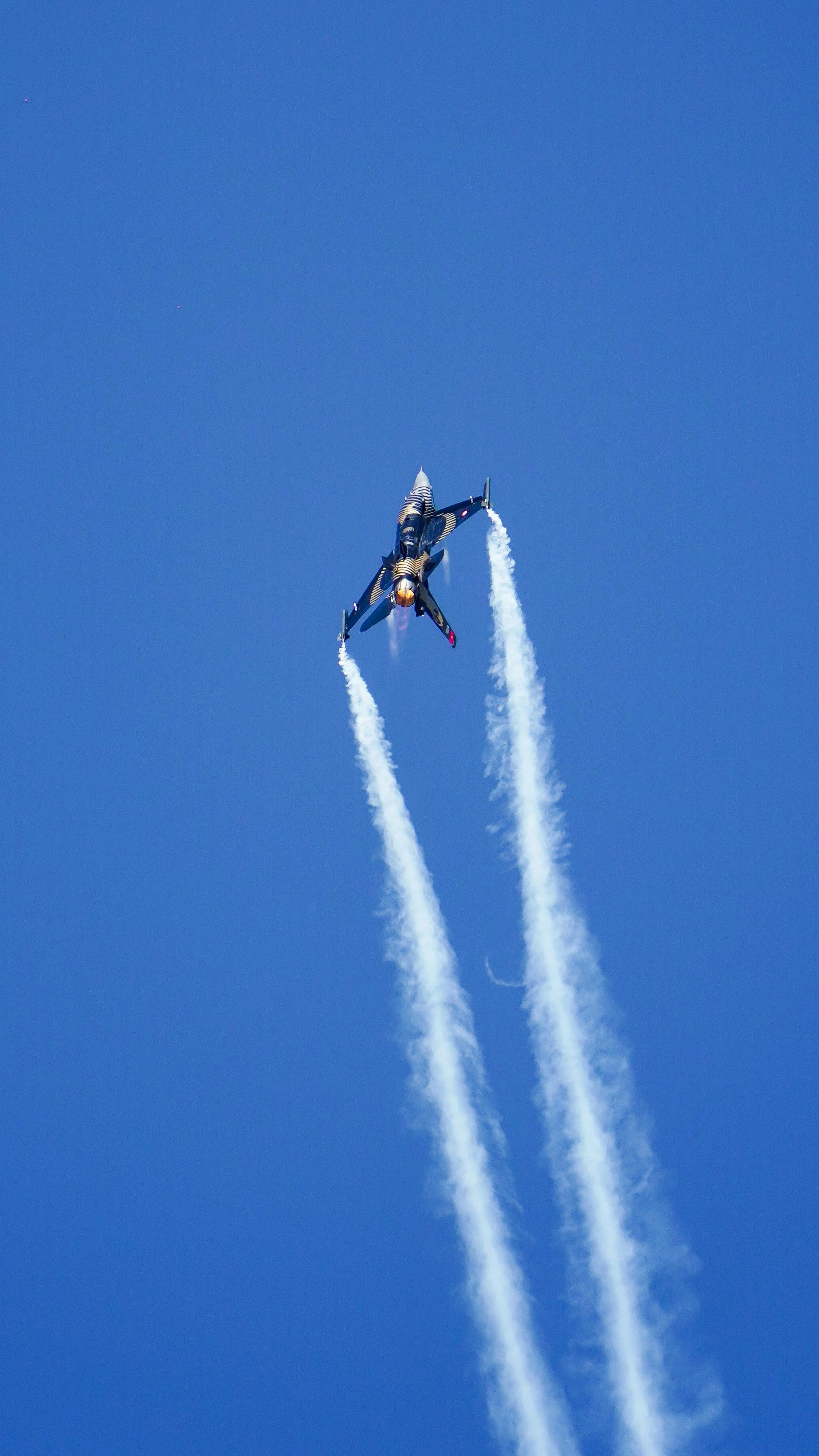 Jet Airplane Performing Aerobatics Against Clear Sky · Free Stock Photo