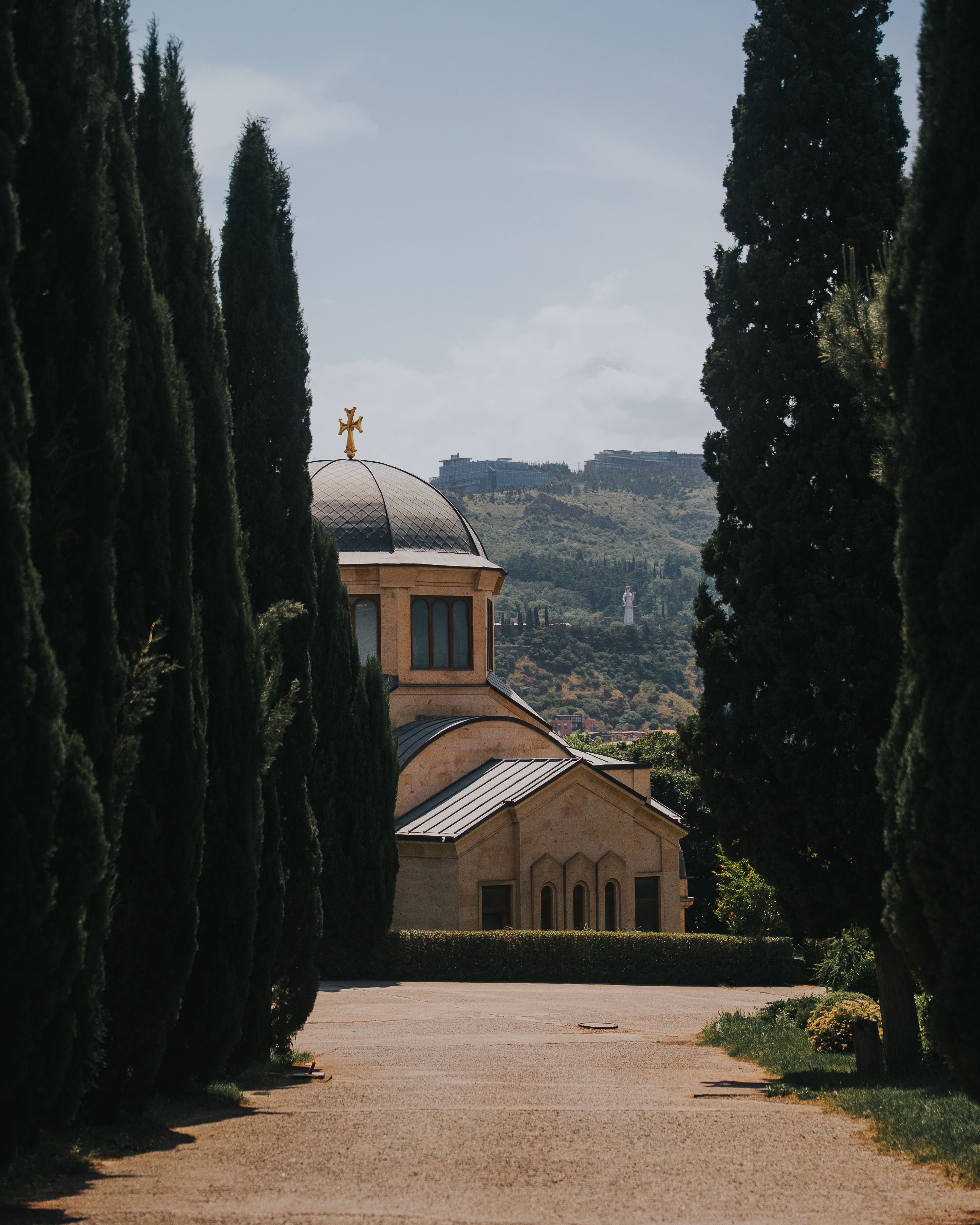 Serene Church in Tbilisi with Cypress Trees · Free Stock Photo
