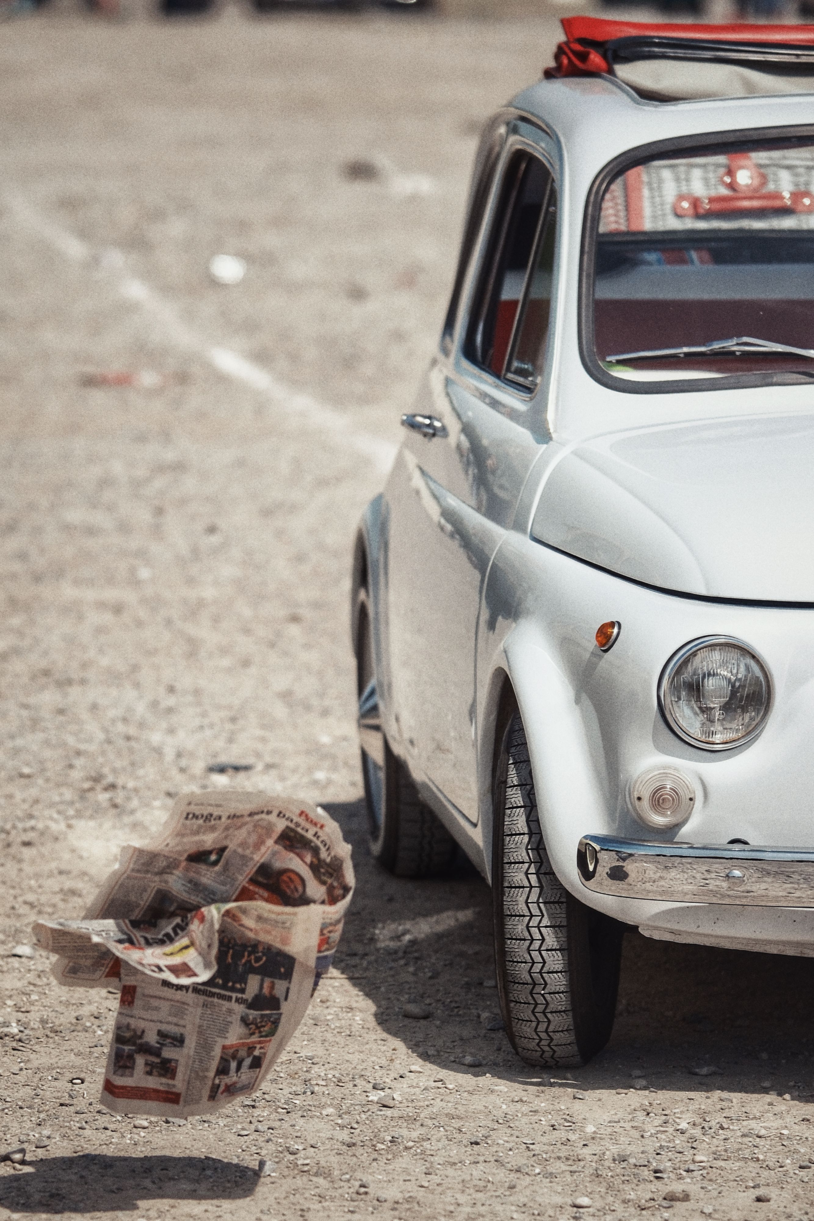 Vintage Car with Newspaper in Motion on Gravel · Free Stock Photo