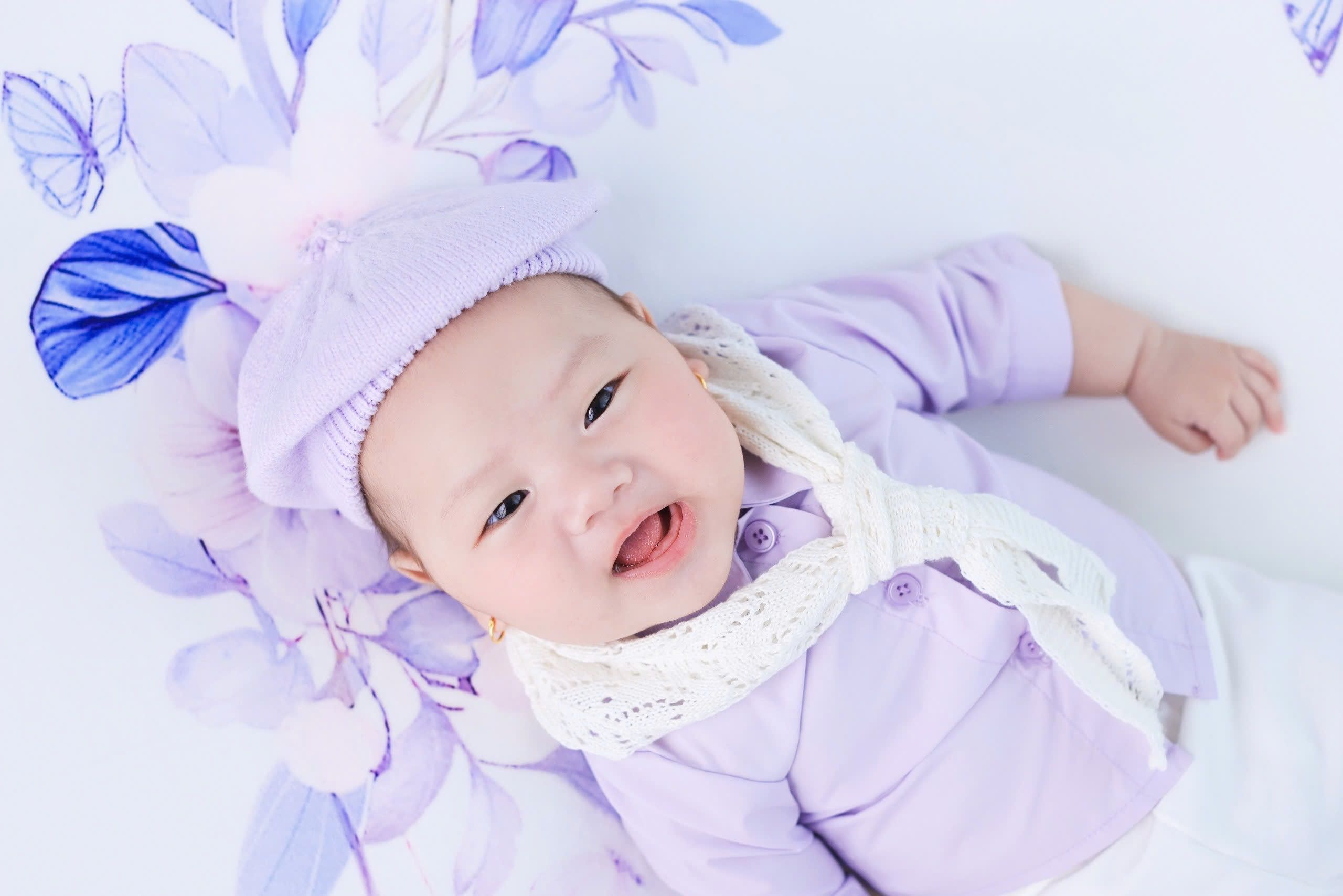 Adorable Baby in Lavender Outfit with Soft Scarf · Free Stock Photo