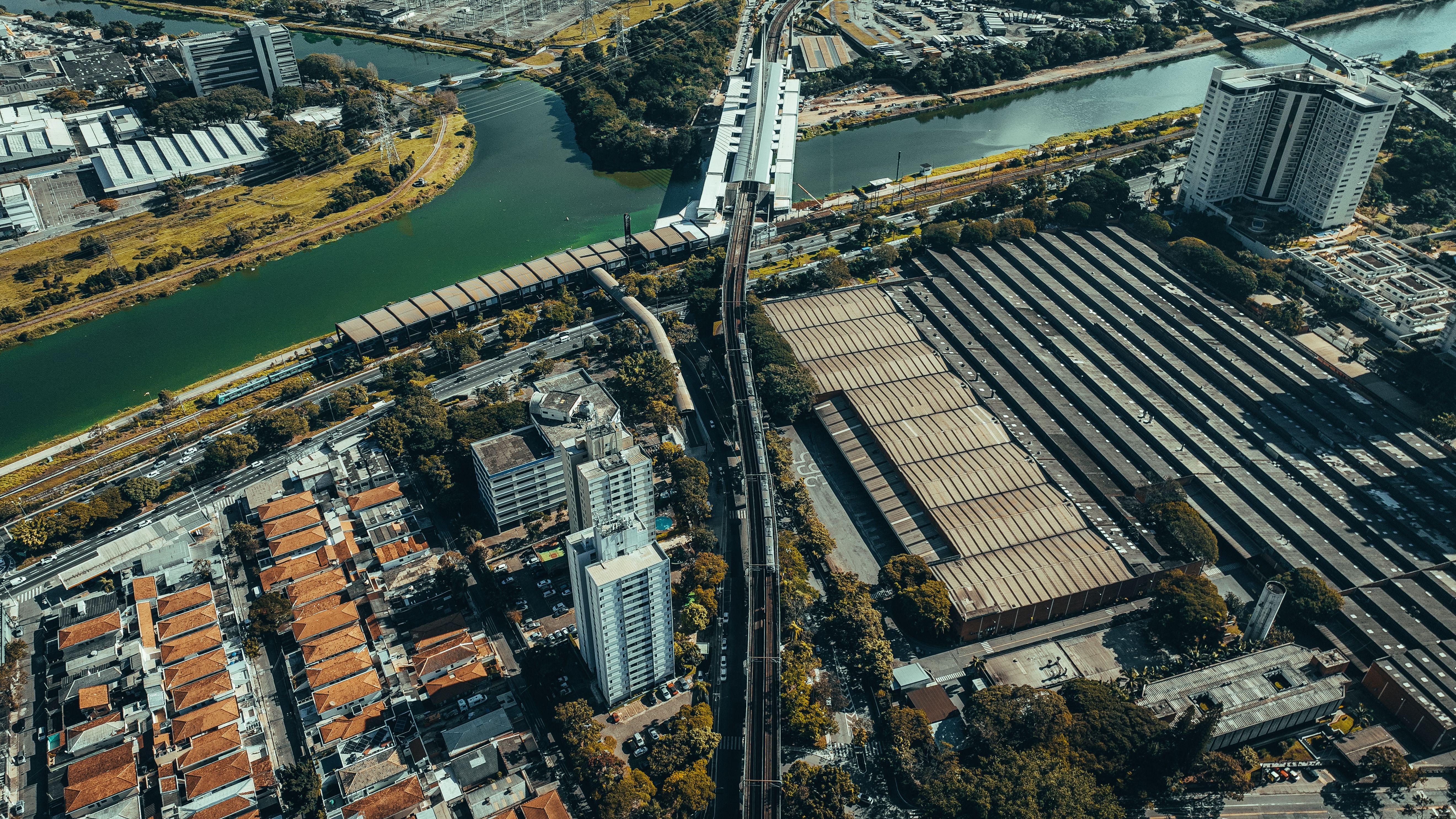 Aerial View of Urban Landscape with River and Buildings · Free Stock Photo