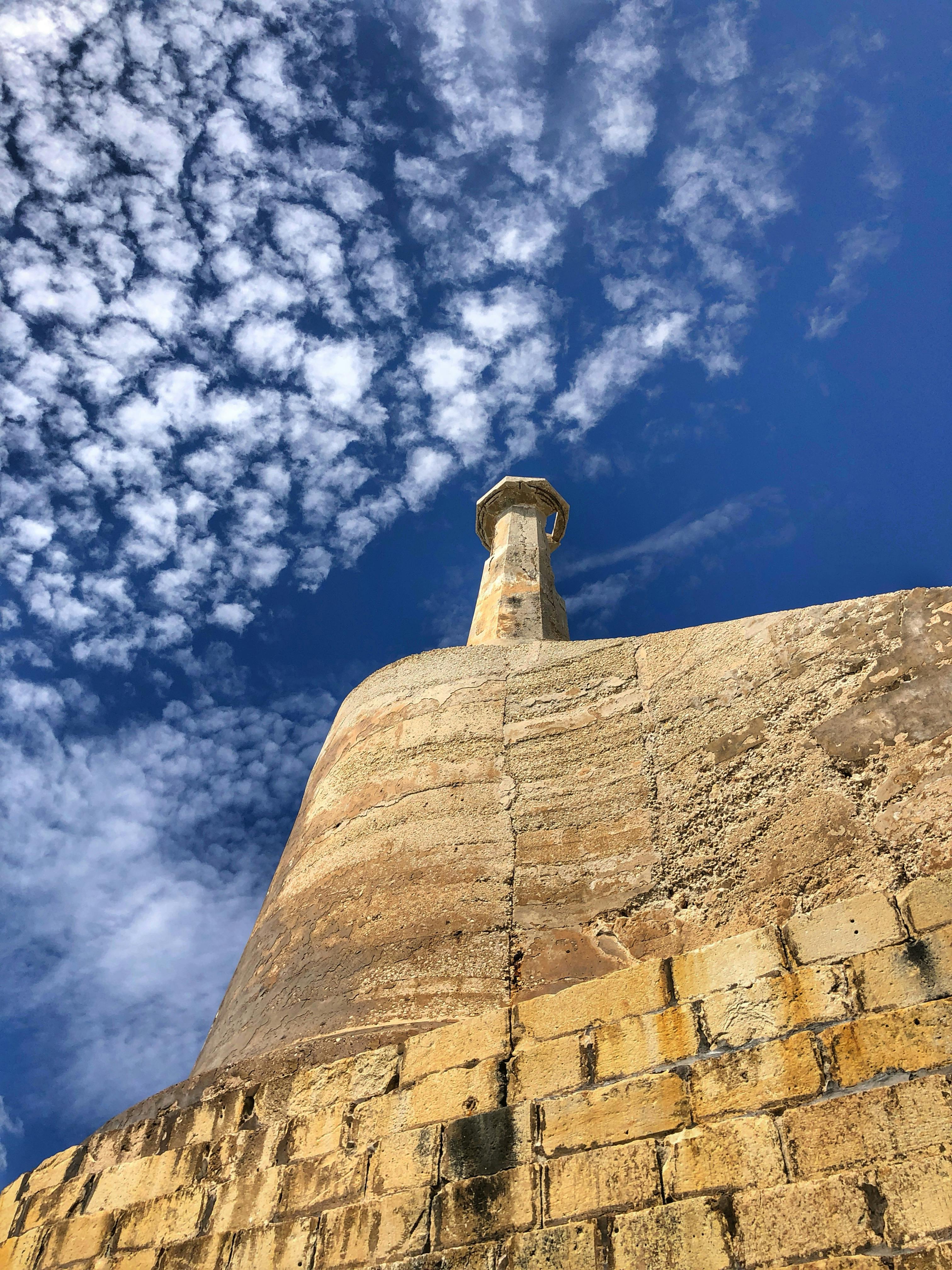 Historic Maltese Watchtower Under Blue Sky · Free Stock Photo