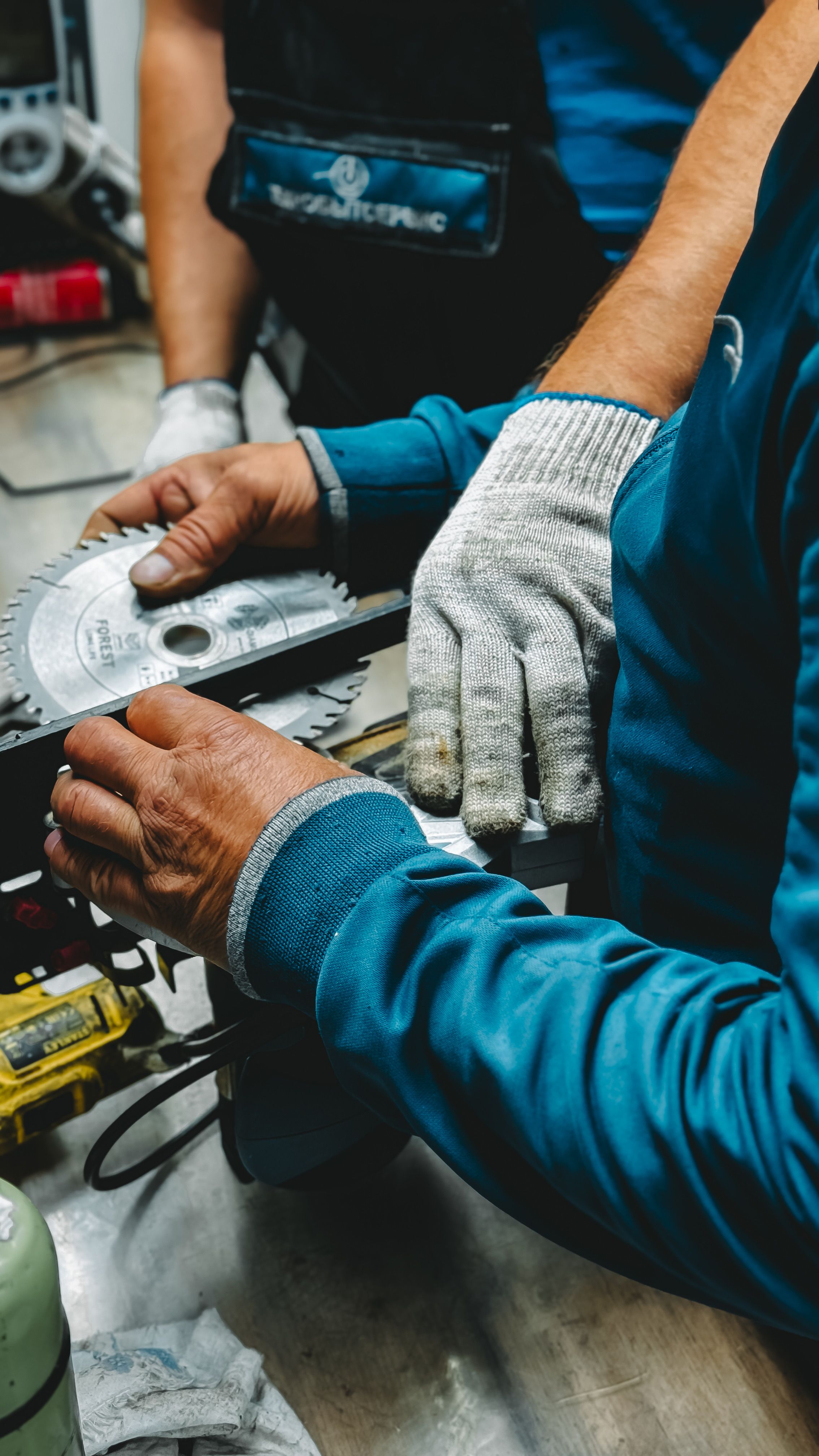Technicians Working with Circular Saw Blade · Free Stock Photo