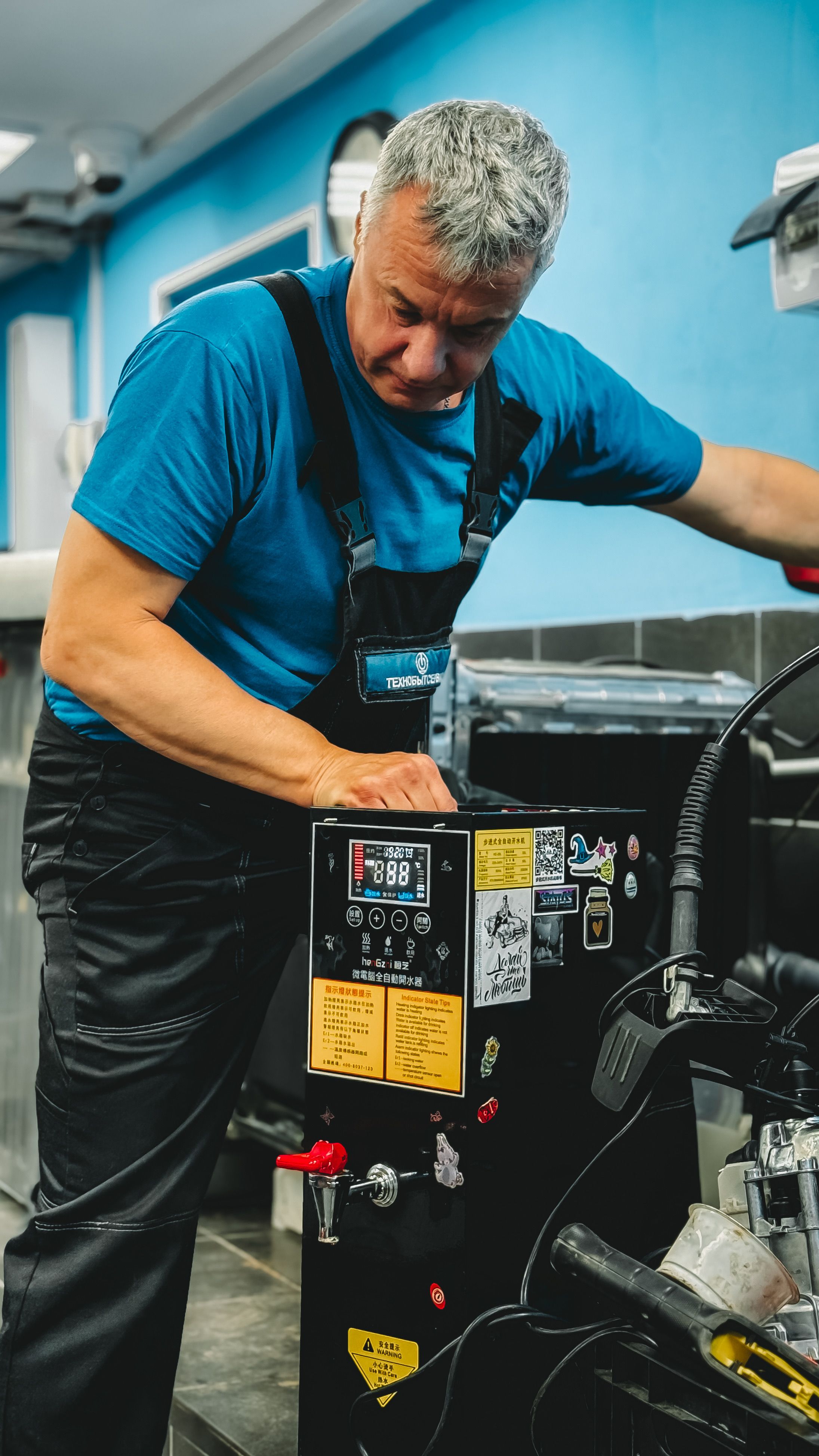Mechanic Repairing Equipment in Workshop · Free Stock Photo