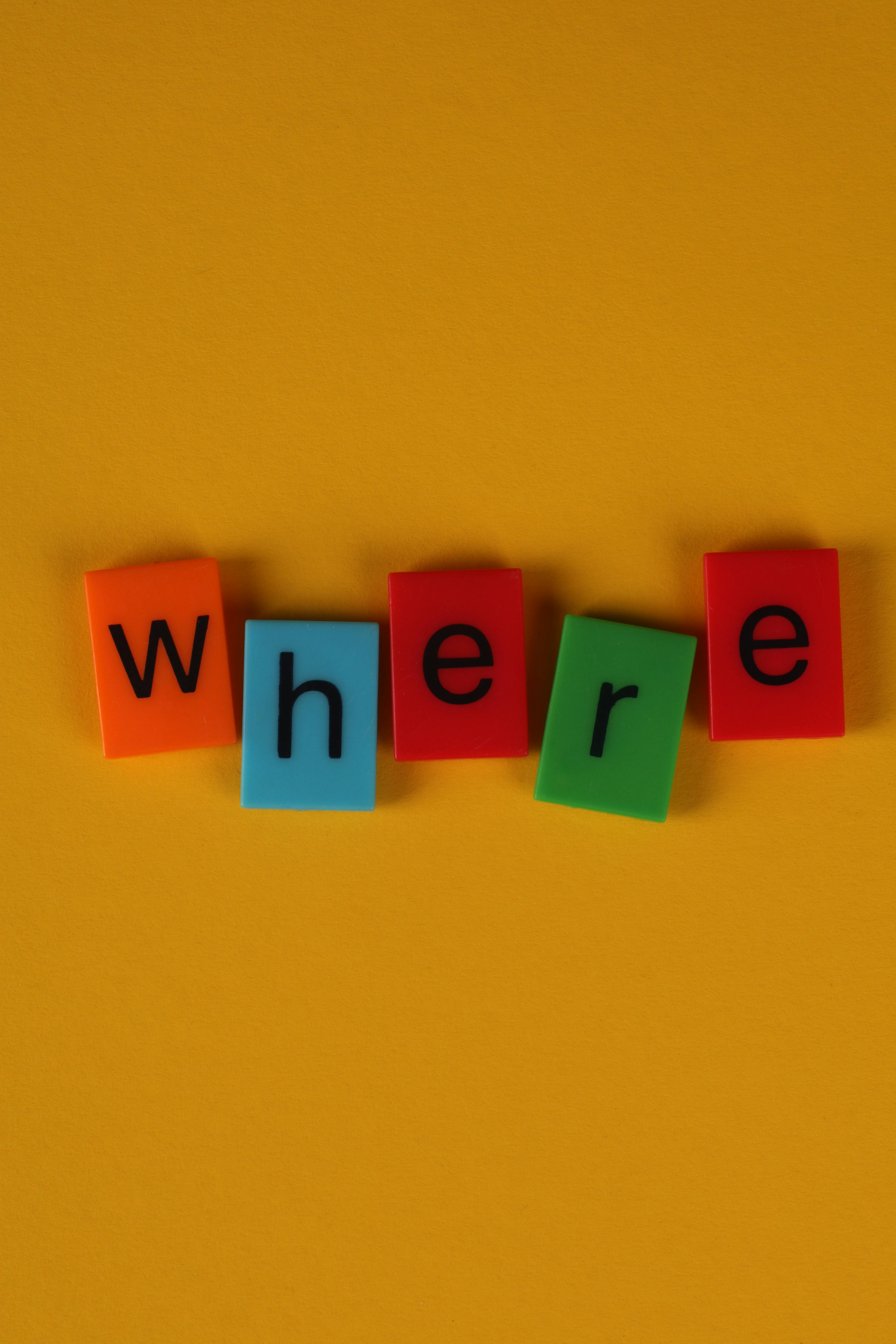 Colorful Word Tiles Spell 'Where' on Yellow · Free Stock Photo