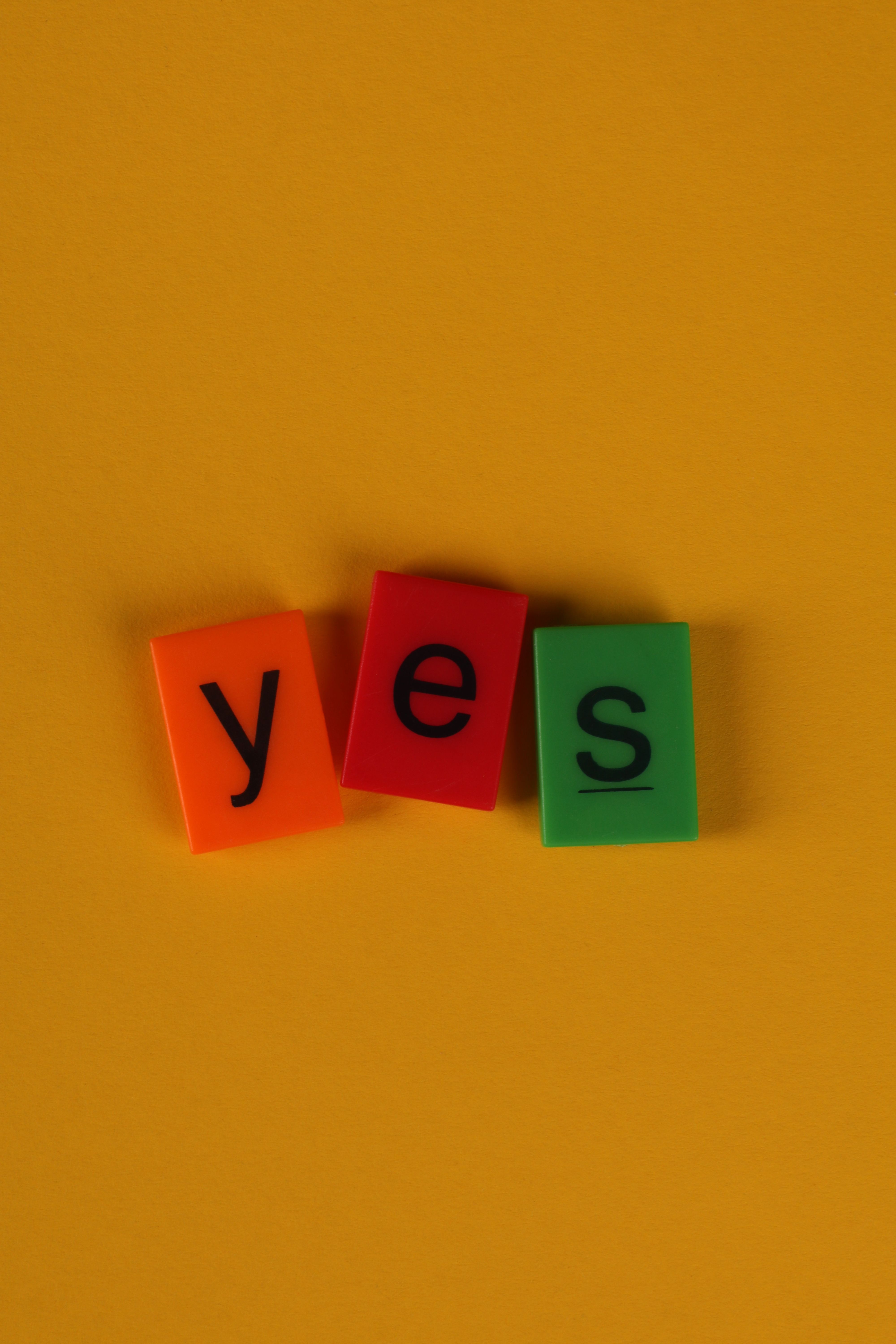 Colorful Blocks Spelling 'Yes' on Yellow Background · Free Stock Photo