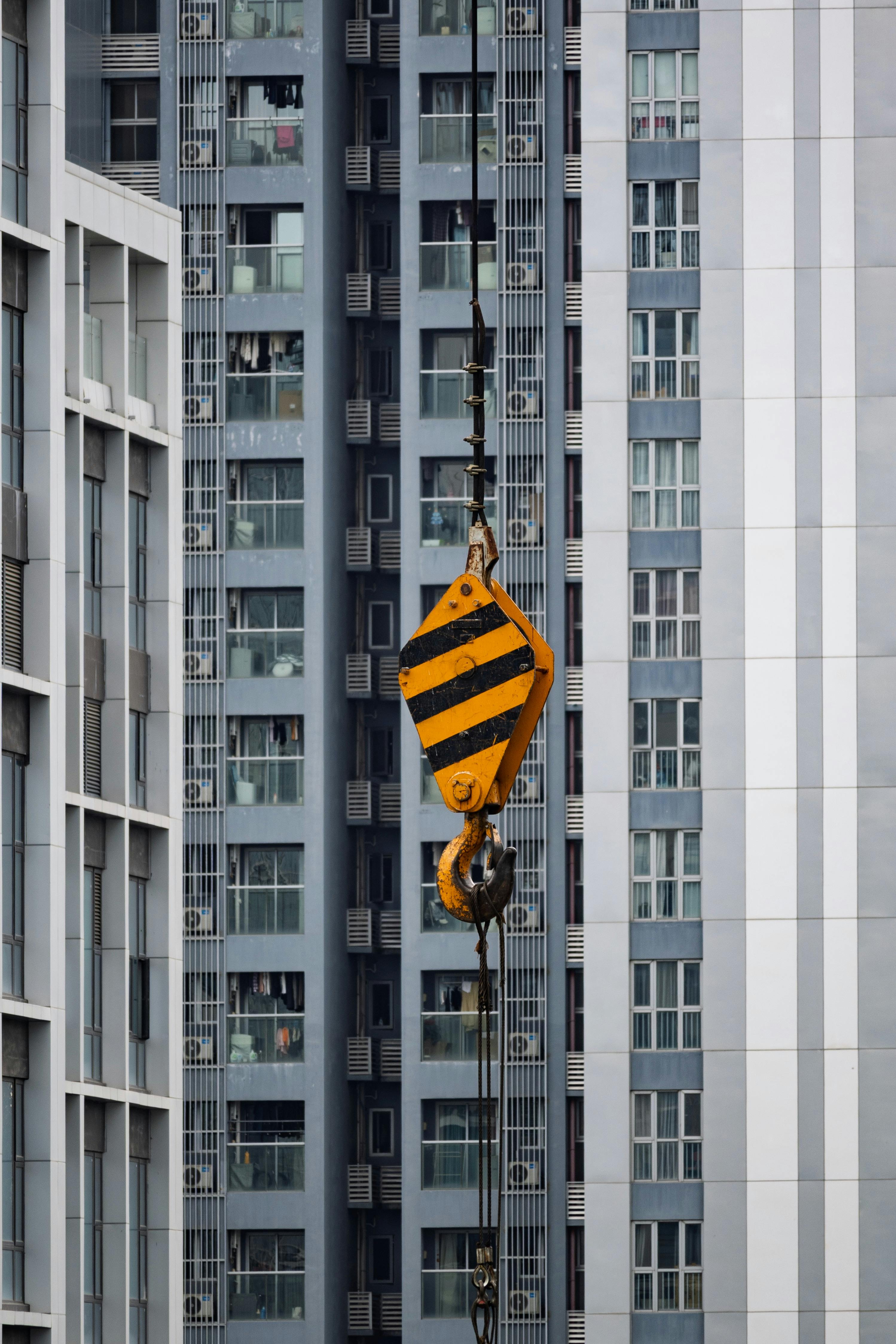 Urban Construction Site with Tower Crane Hook · Free Stock Photo