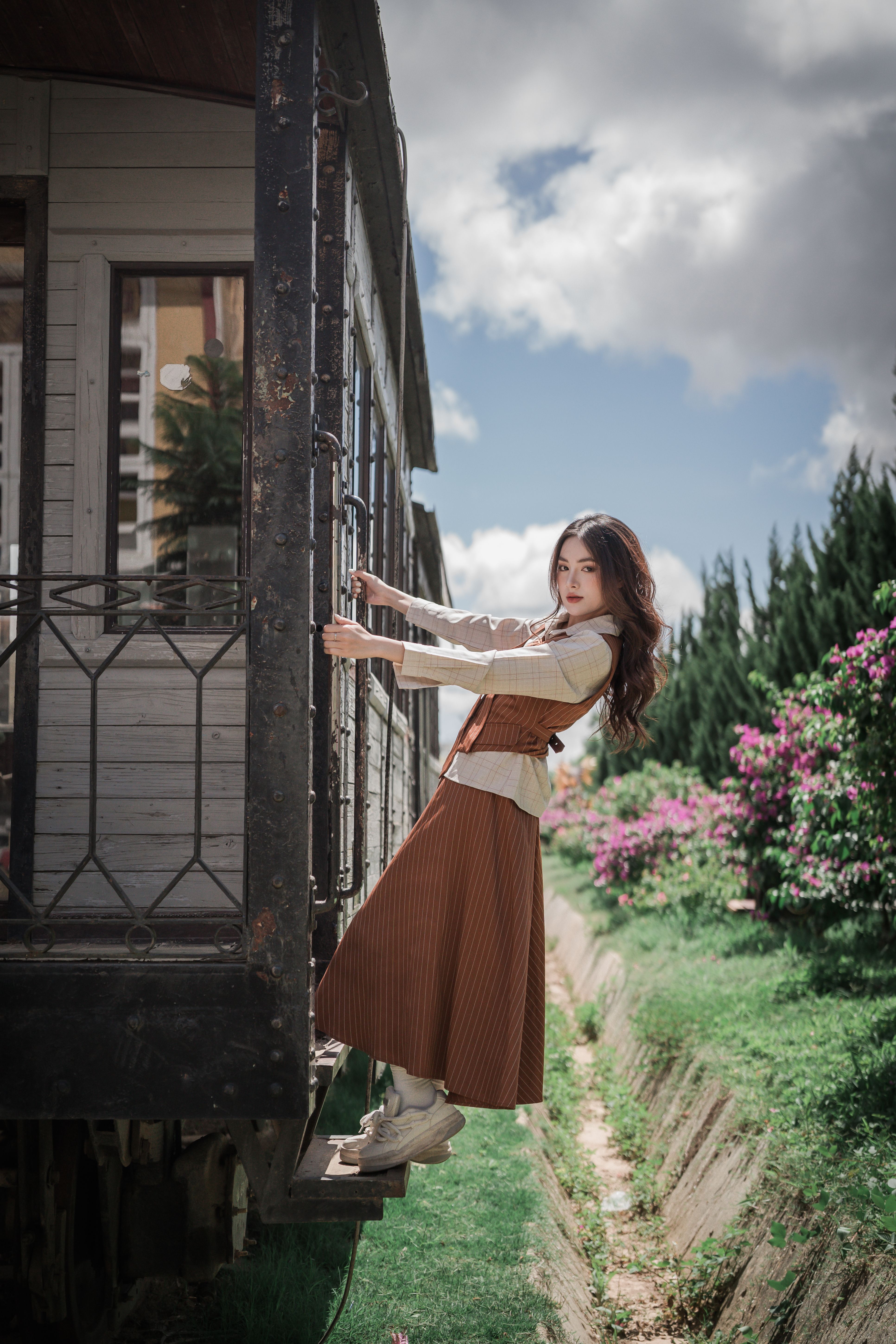 Woman in Vintage Clothing Posing on Train Carriage · Free Stock Photo
