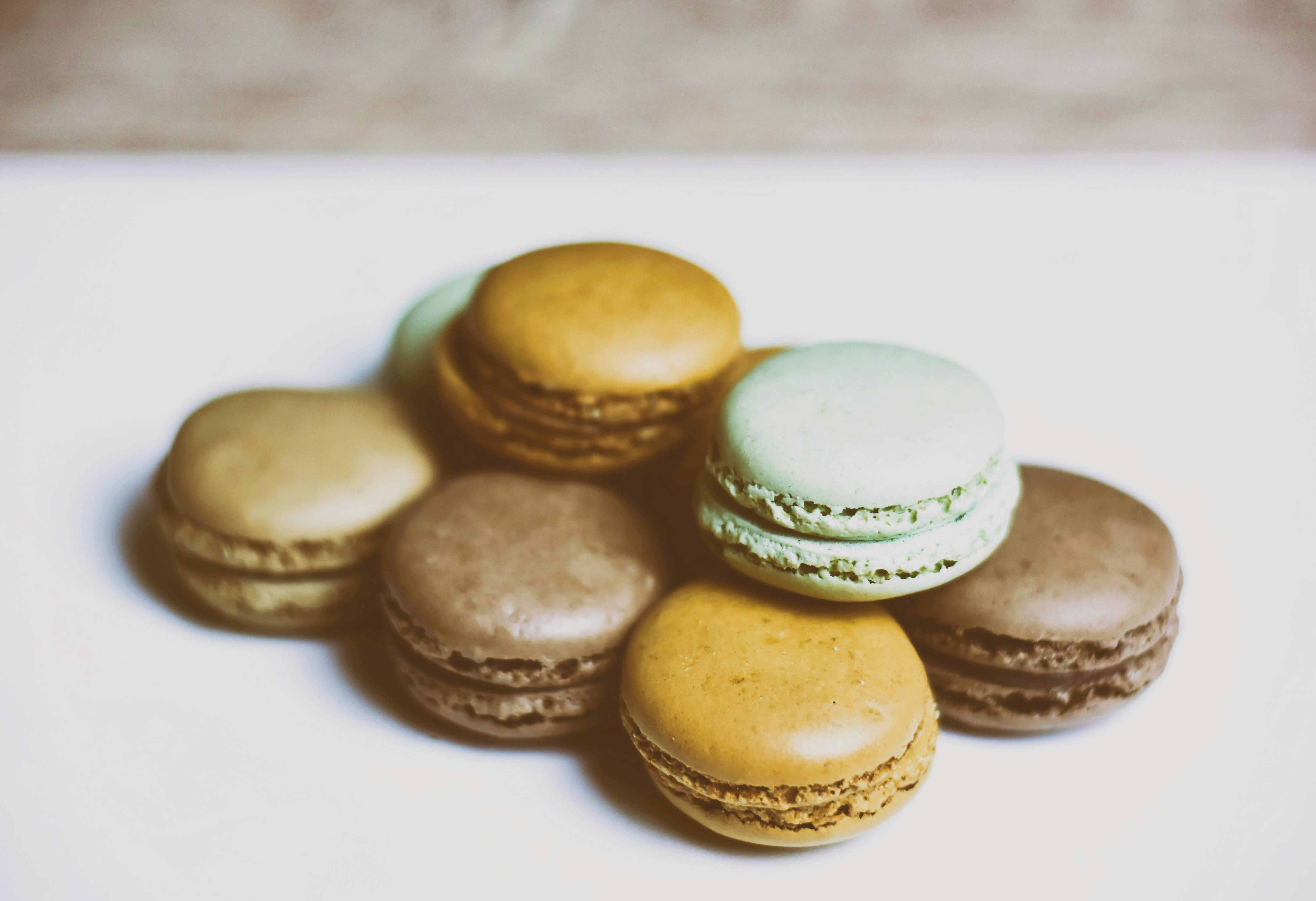 Tasty macaroons placed on white table · Free Stock Photo