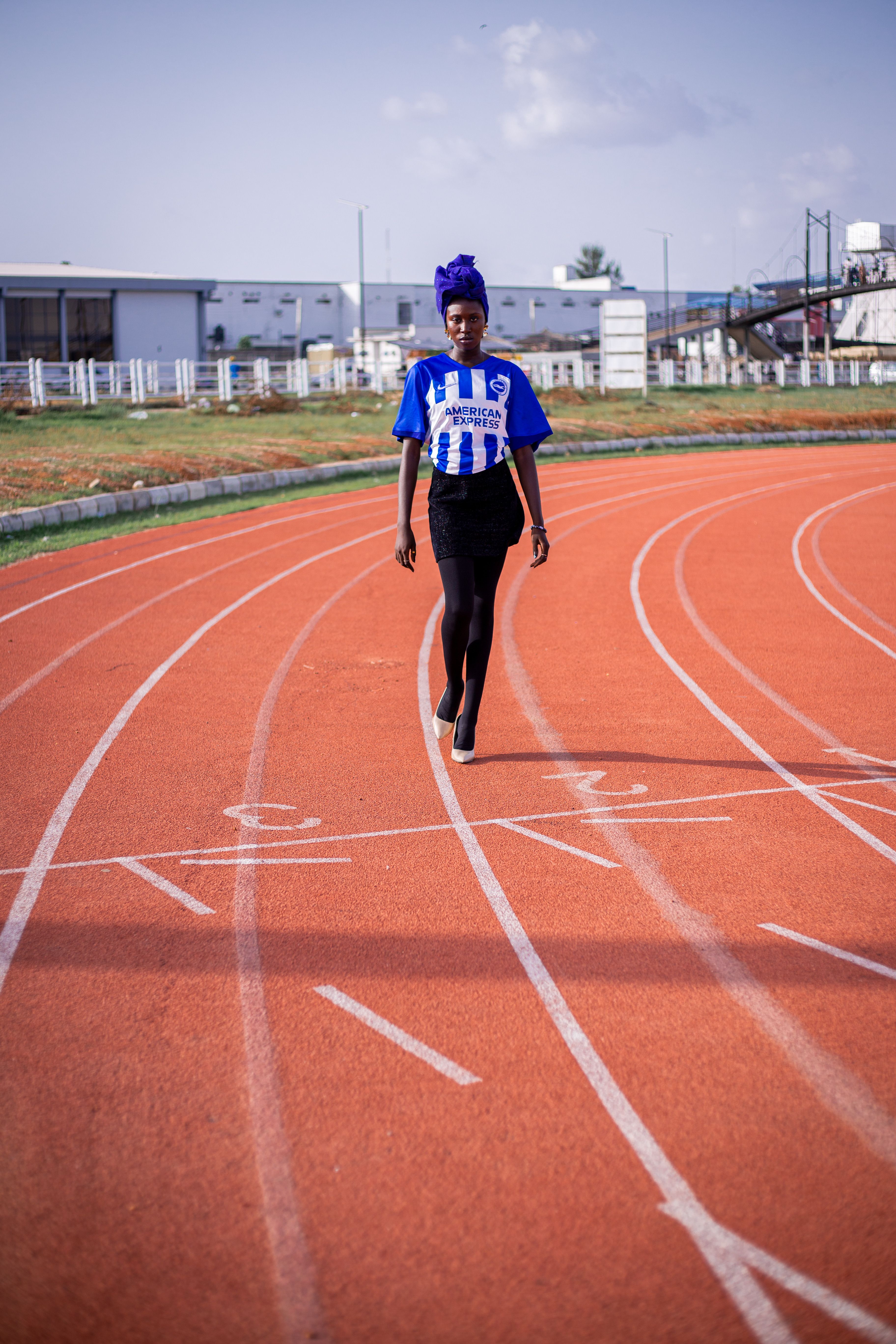 Young Woman Walking on Outdoor Athletic Track · Free Stock Photo