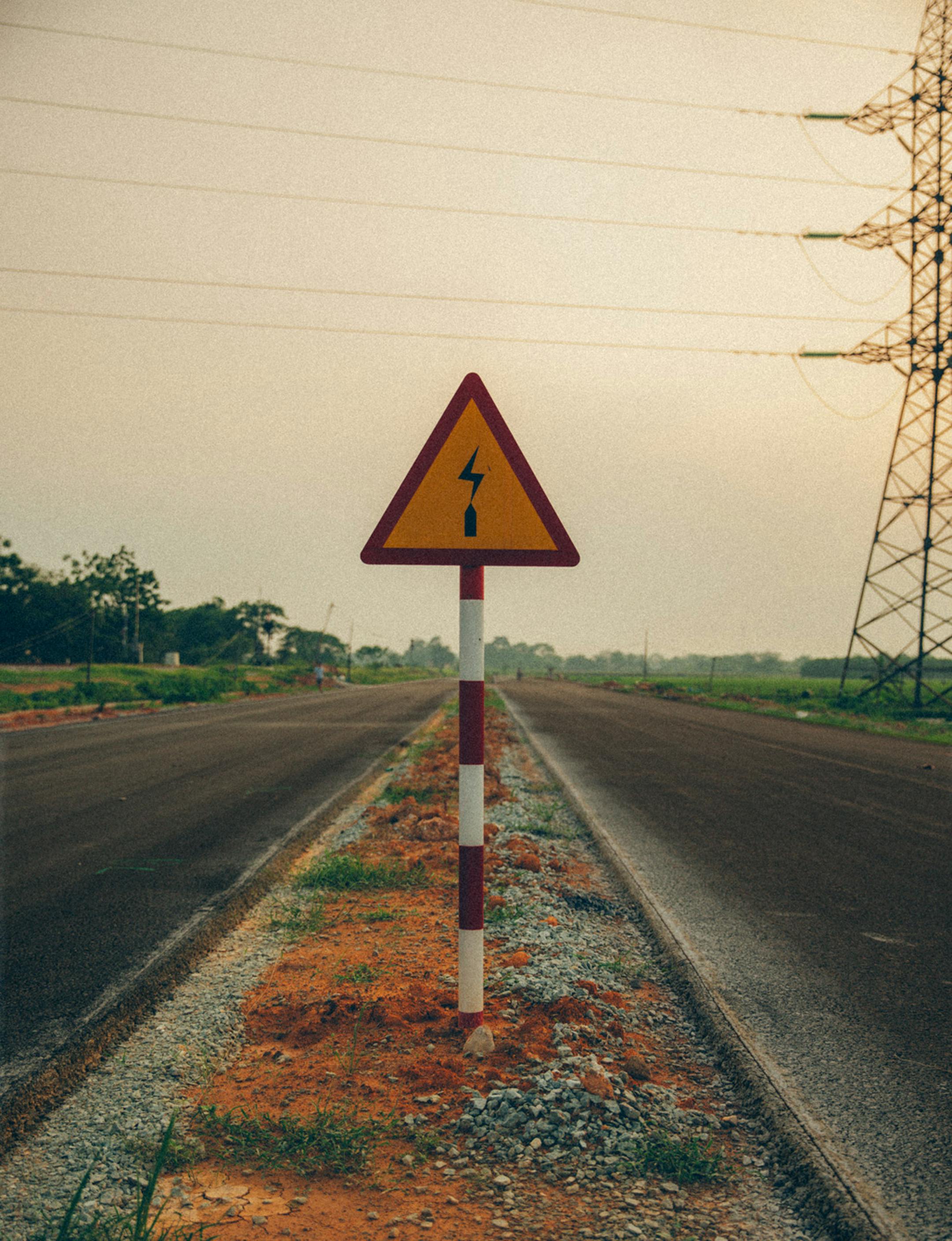 Rural Road with Power Line Warning Sign · Free Stock Photo