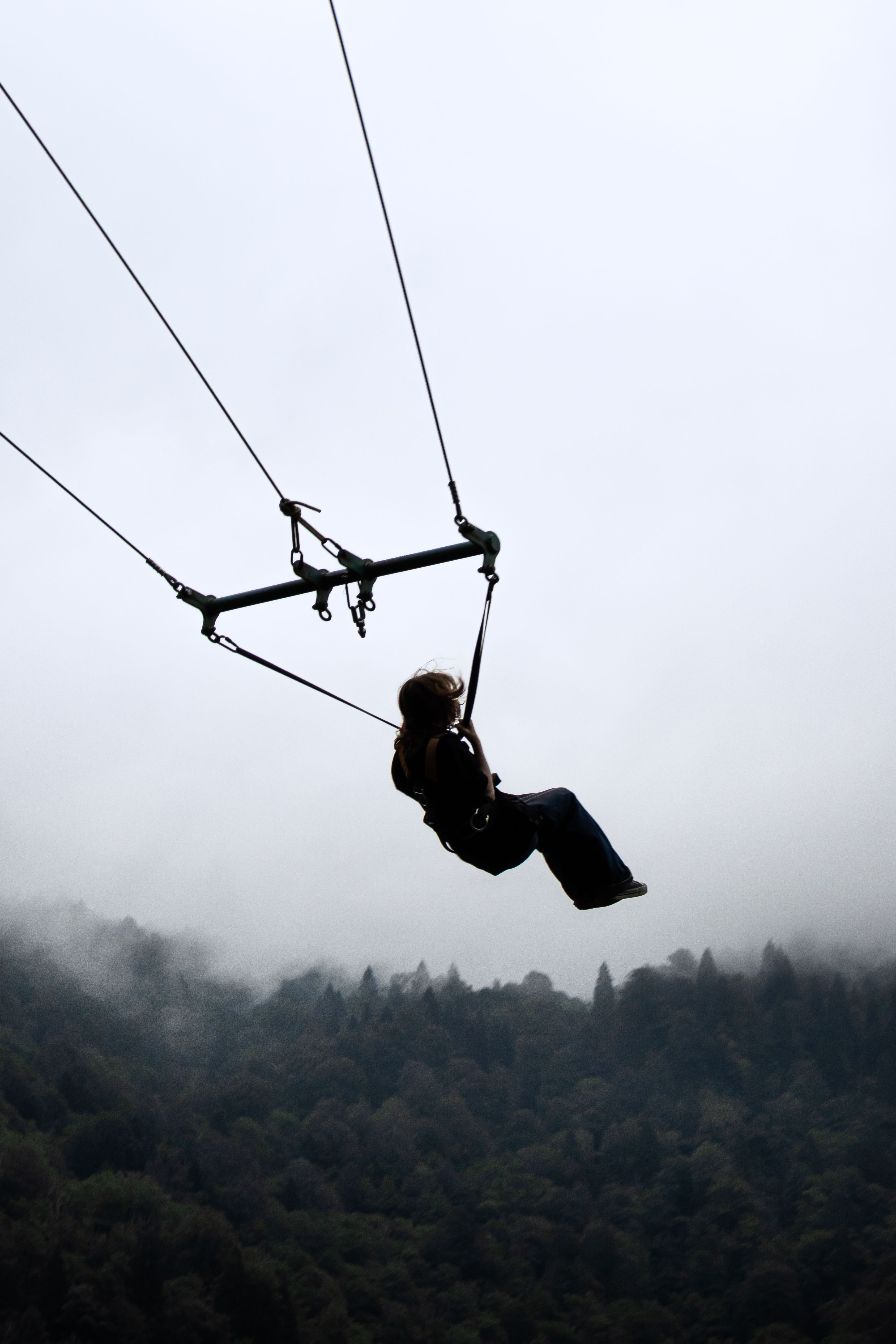 Silhouette on Swing Over Misty Rize Mountains · Free Stock Photo