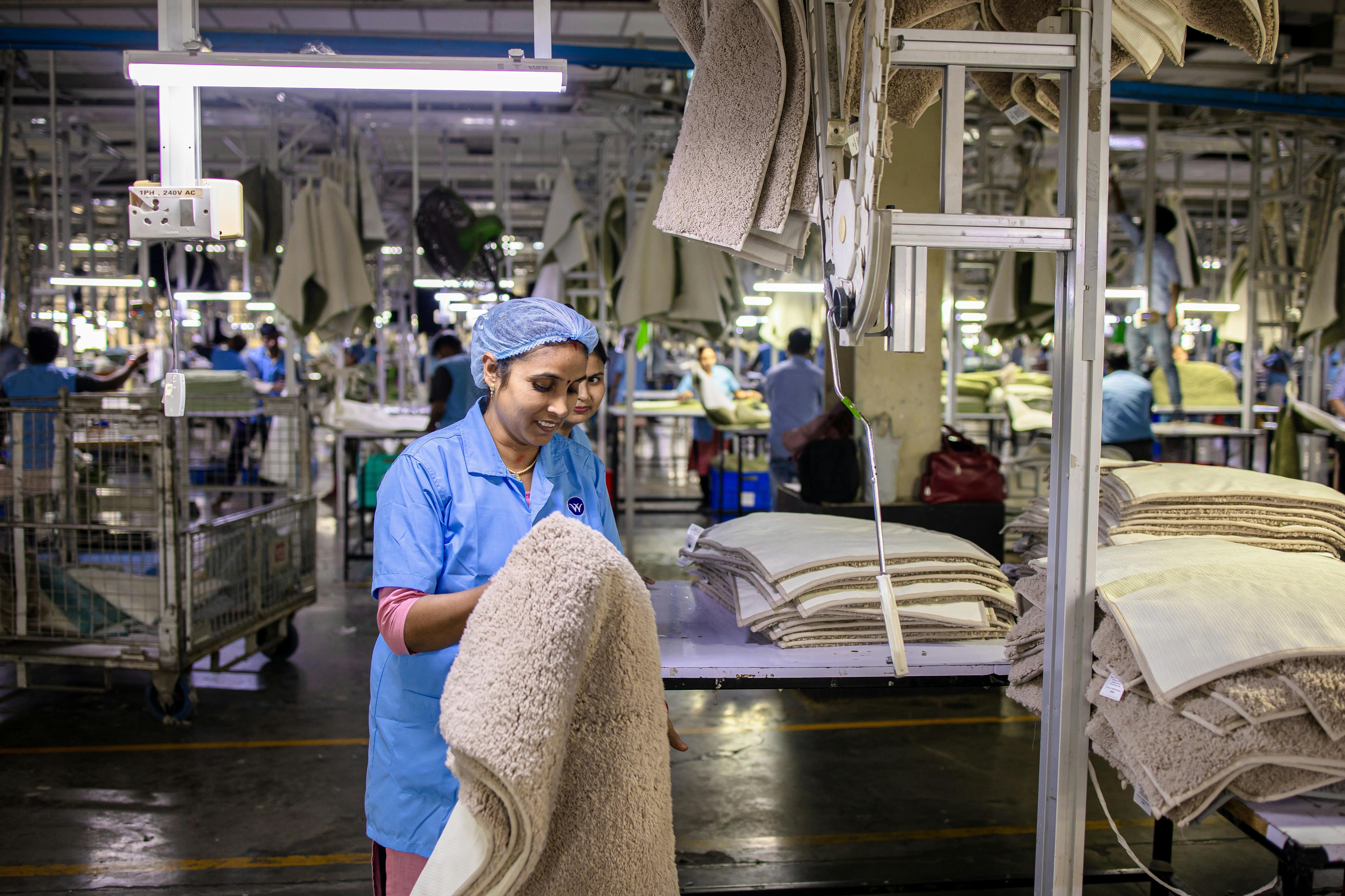 Indian Textile Factory Worker Sorting Fabric · Free Stock Photo