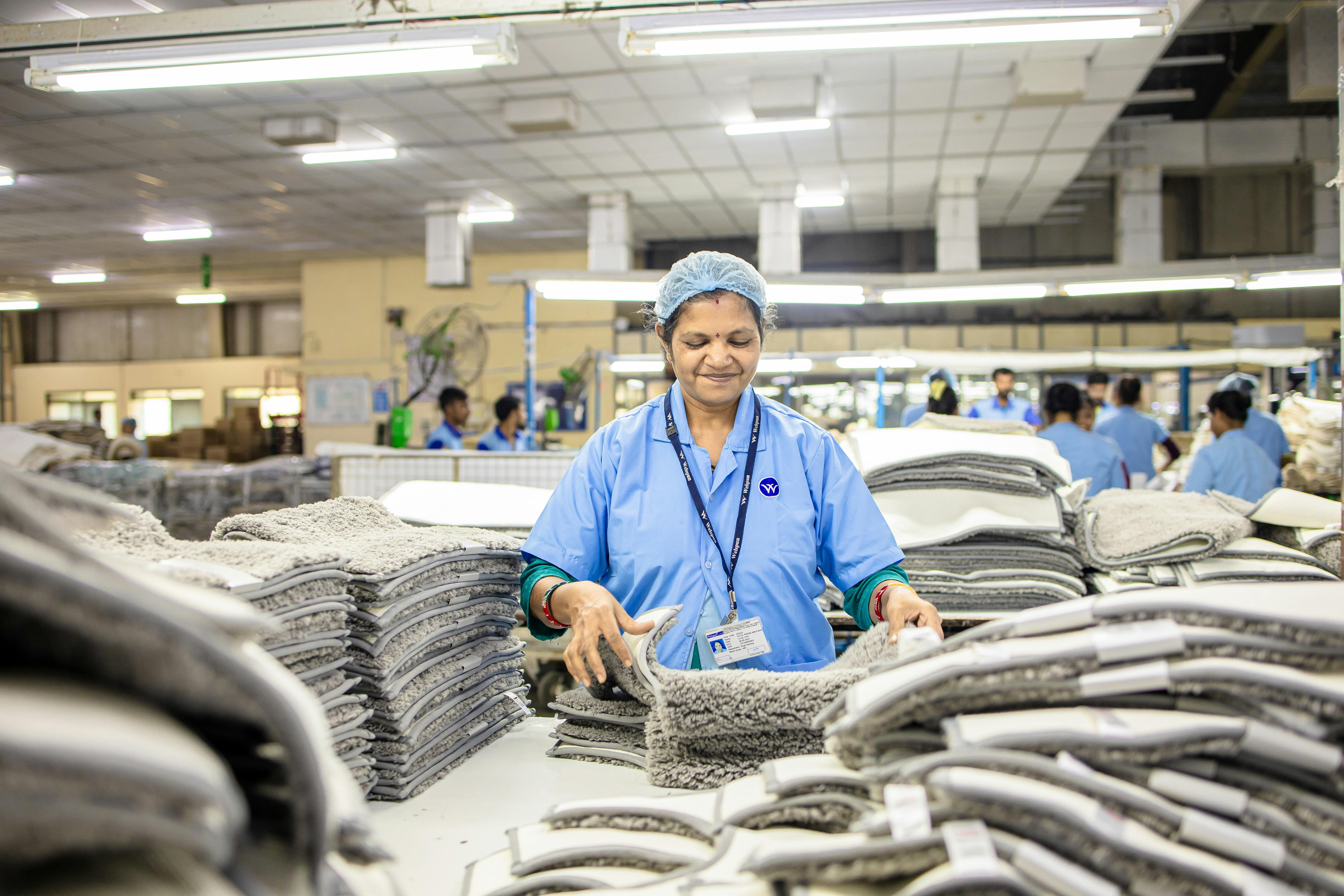 Textile Factory Worker Sorting Fabrics · Free Stock Photo