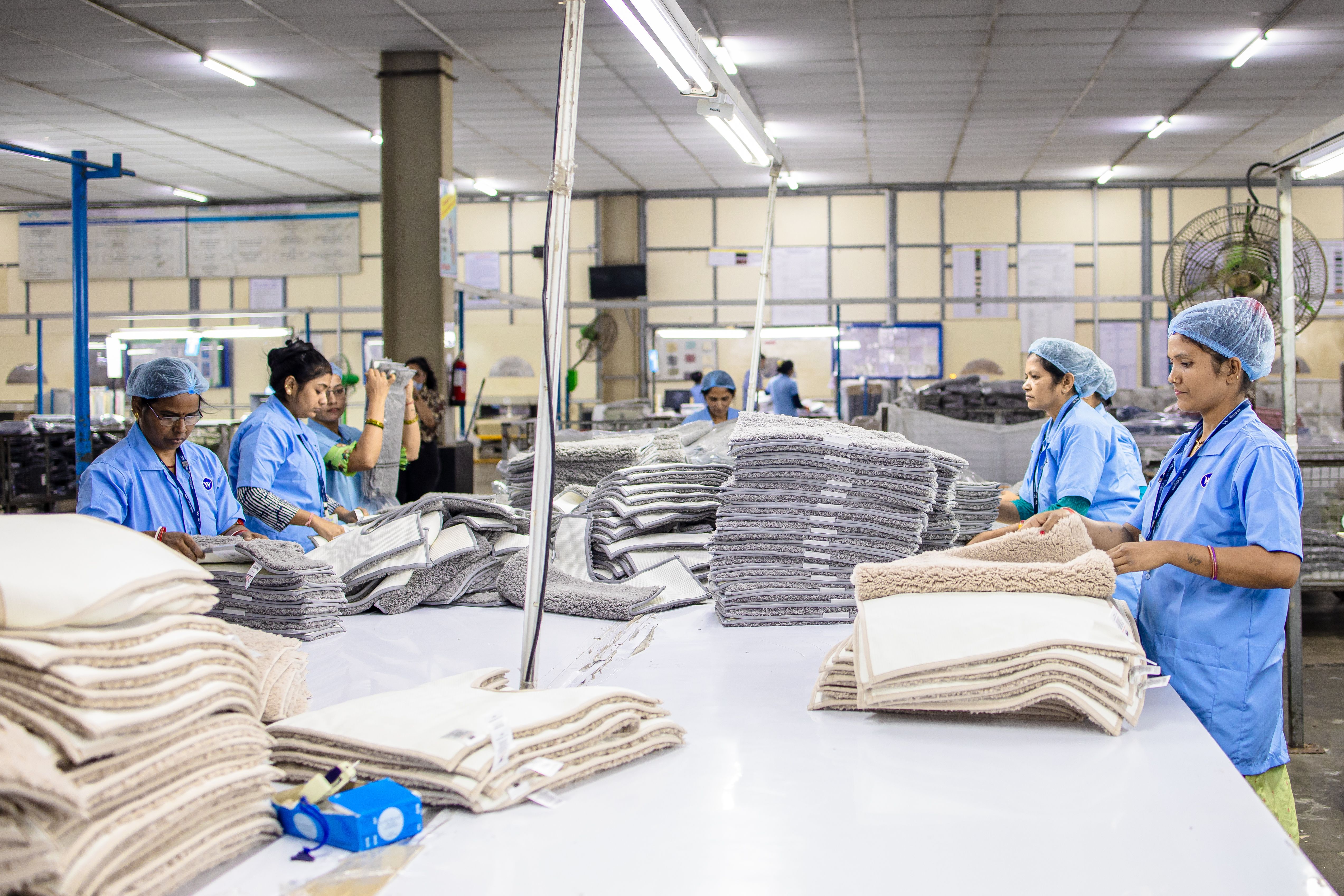 Textile Factory Workers Sorting Material Indoors · Free Stock Photo